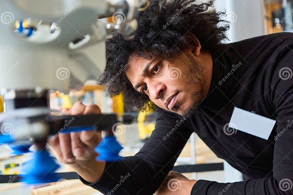 Engineer Programming Robotic Gripper Arm for Industrial Application and ...