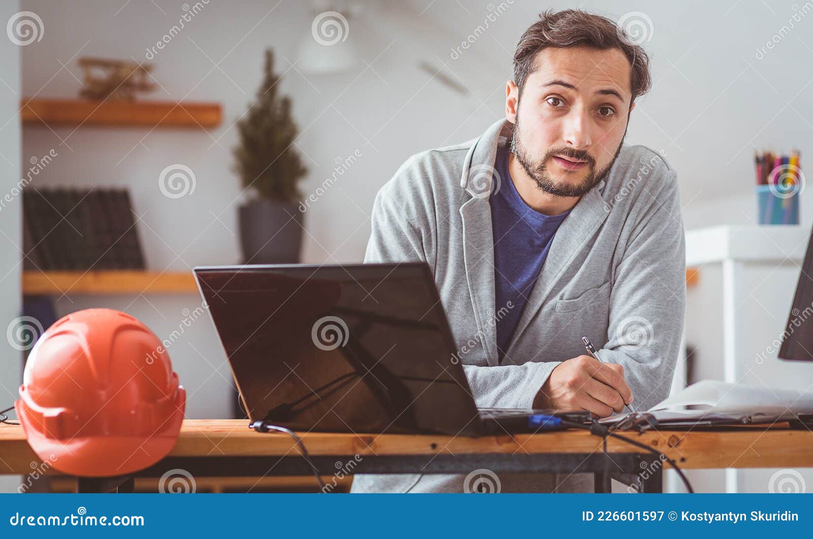 An Engineer with a Questioning Expression Looks in Front of Him at a ...