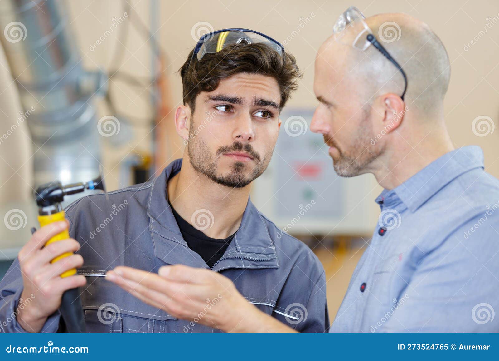 Engineer Questioning Younger Worker Holding Hose Stock Image - Image of ...