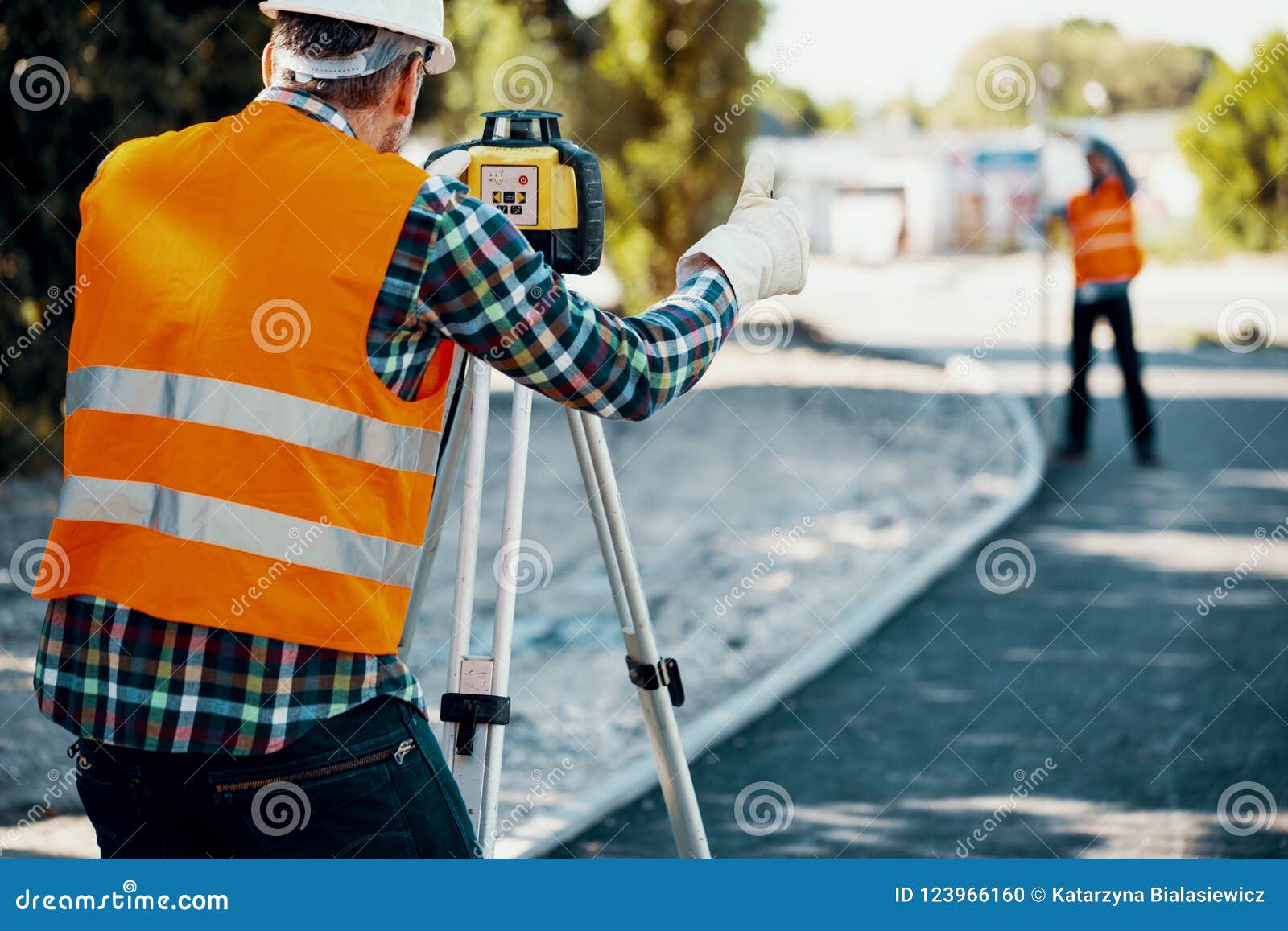Geodetic Engineer Surveyor In White Hard Hat Doing Measurements With ...