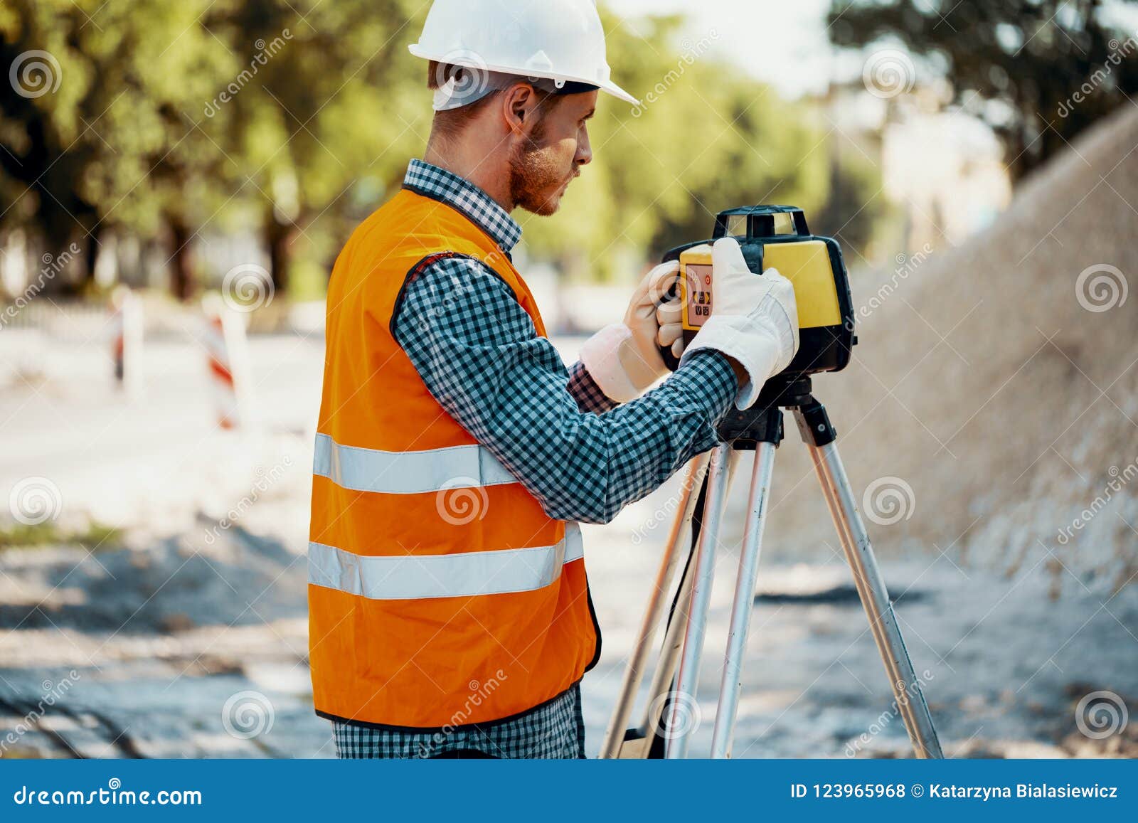 Engineer in Reflective Vest and White Helmet Using Geodetic Equipment ...