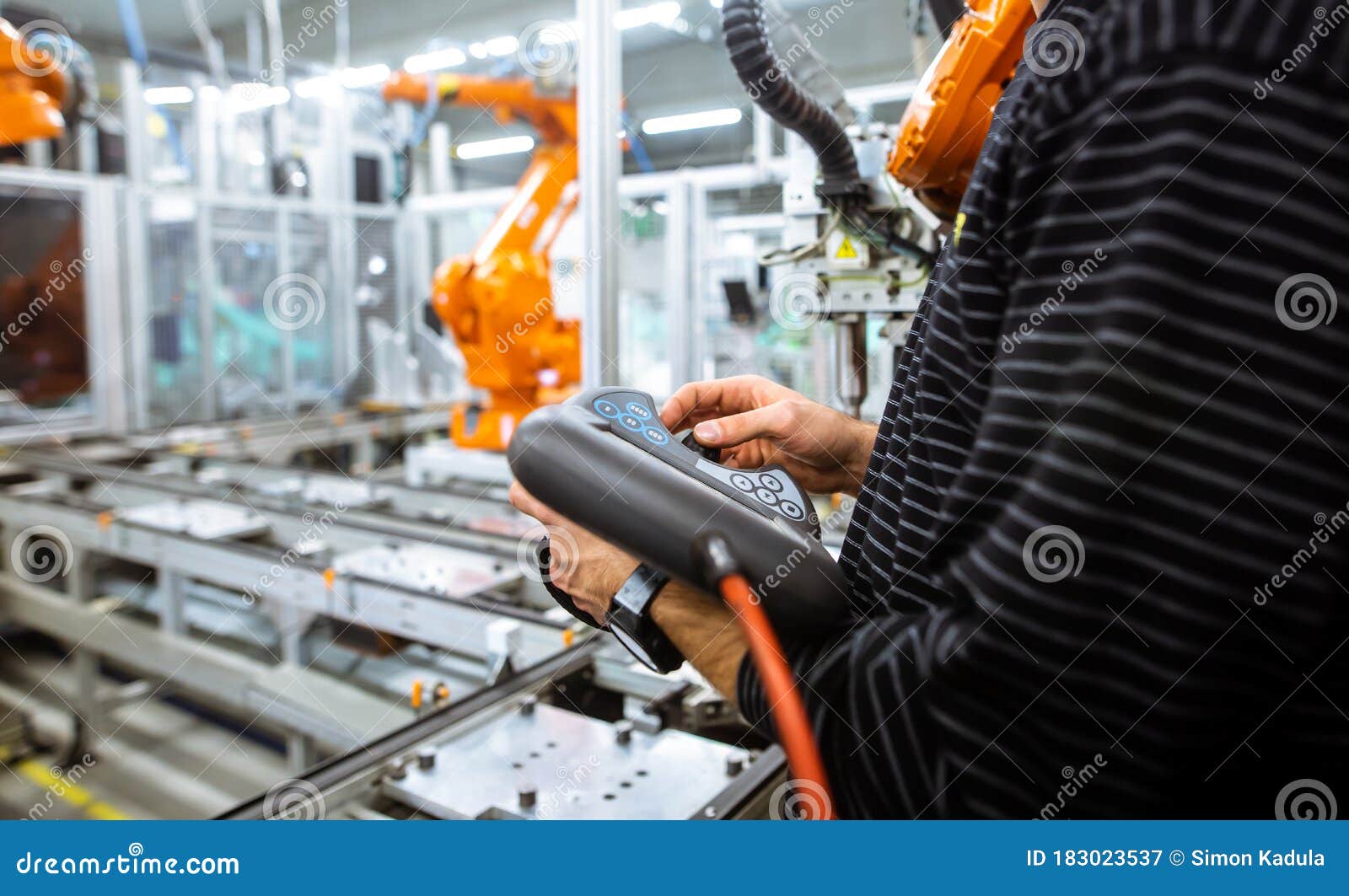 Engineer Setting Up Automatic Robot Arms in the Smart Factory ...