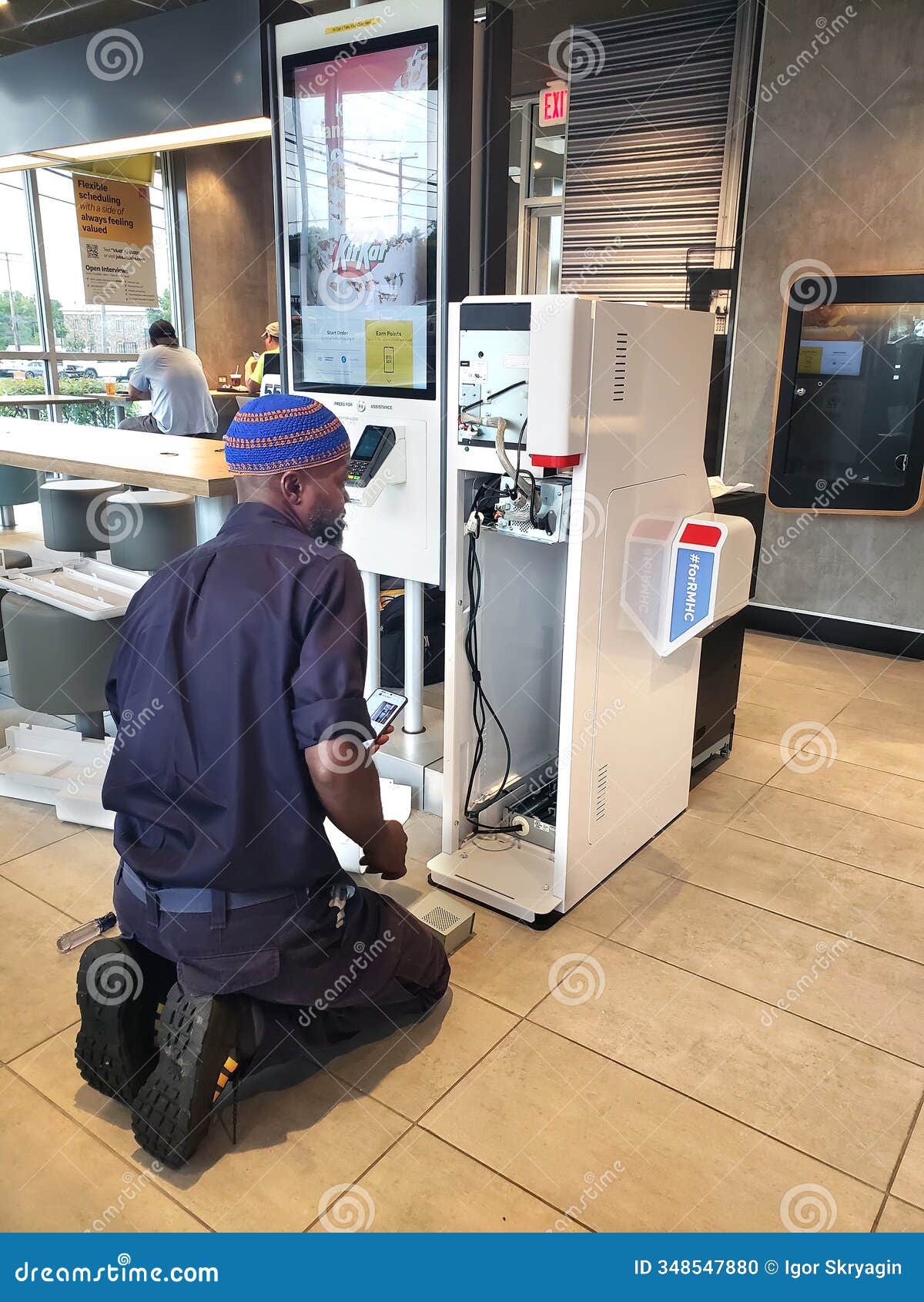 Engineer Setting Up a New Vending Machine To Serve Customers at a ...
