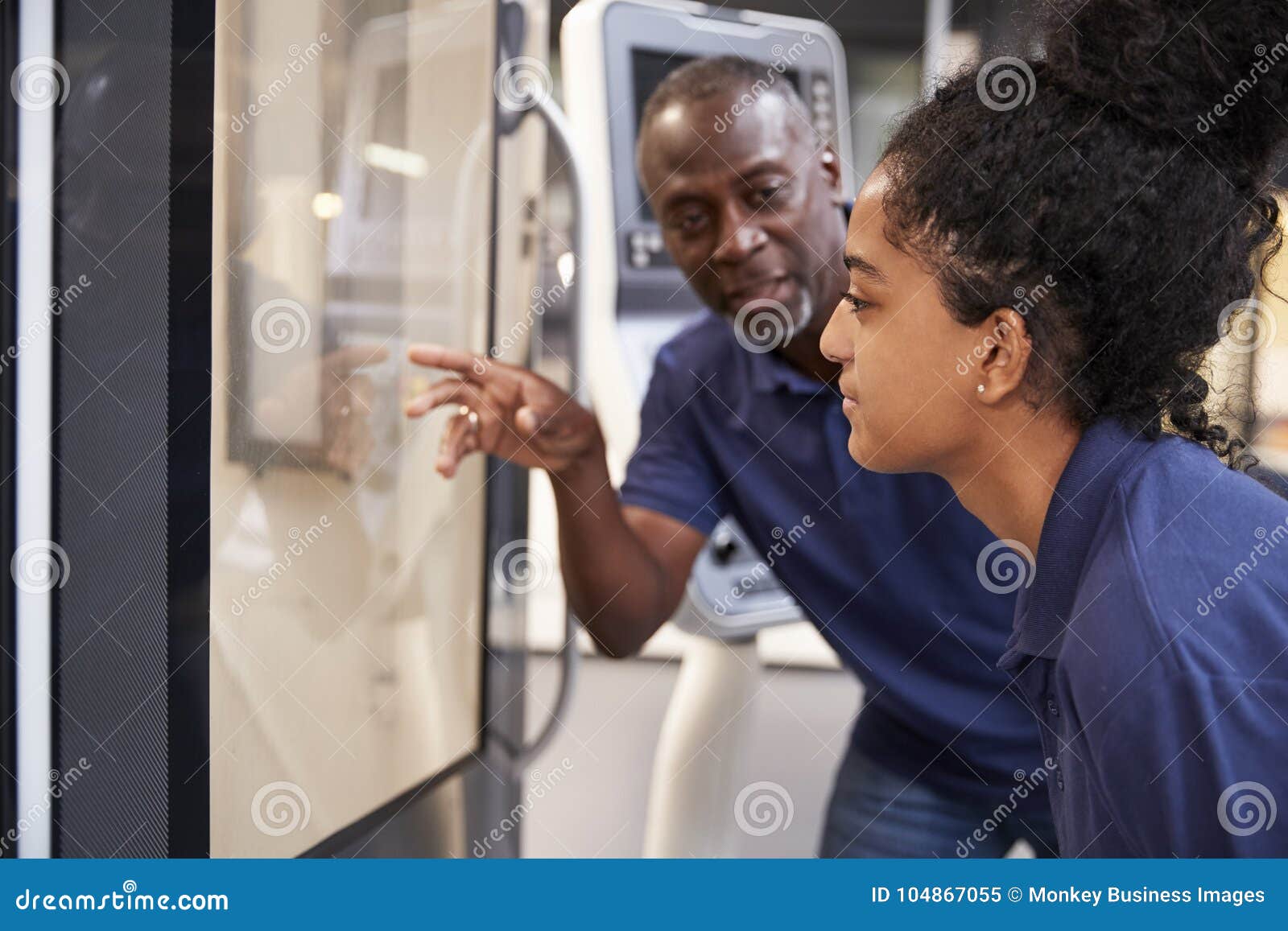 Engineer Showing Apprentice How To Use CNC Tool Making Machine Stock ...
