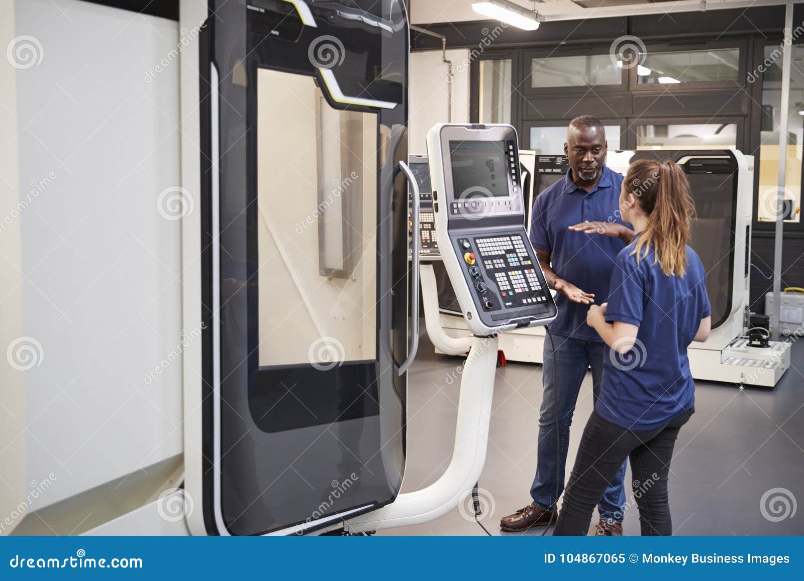 Engineer Showing Apprentice How To Use CNC Tool Making Machine Stock ...