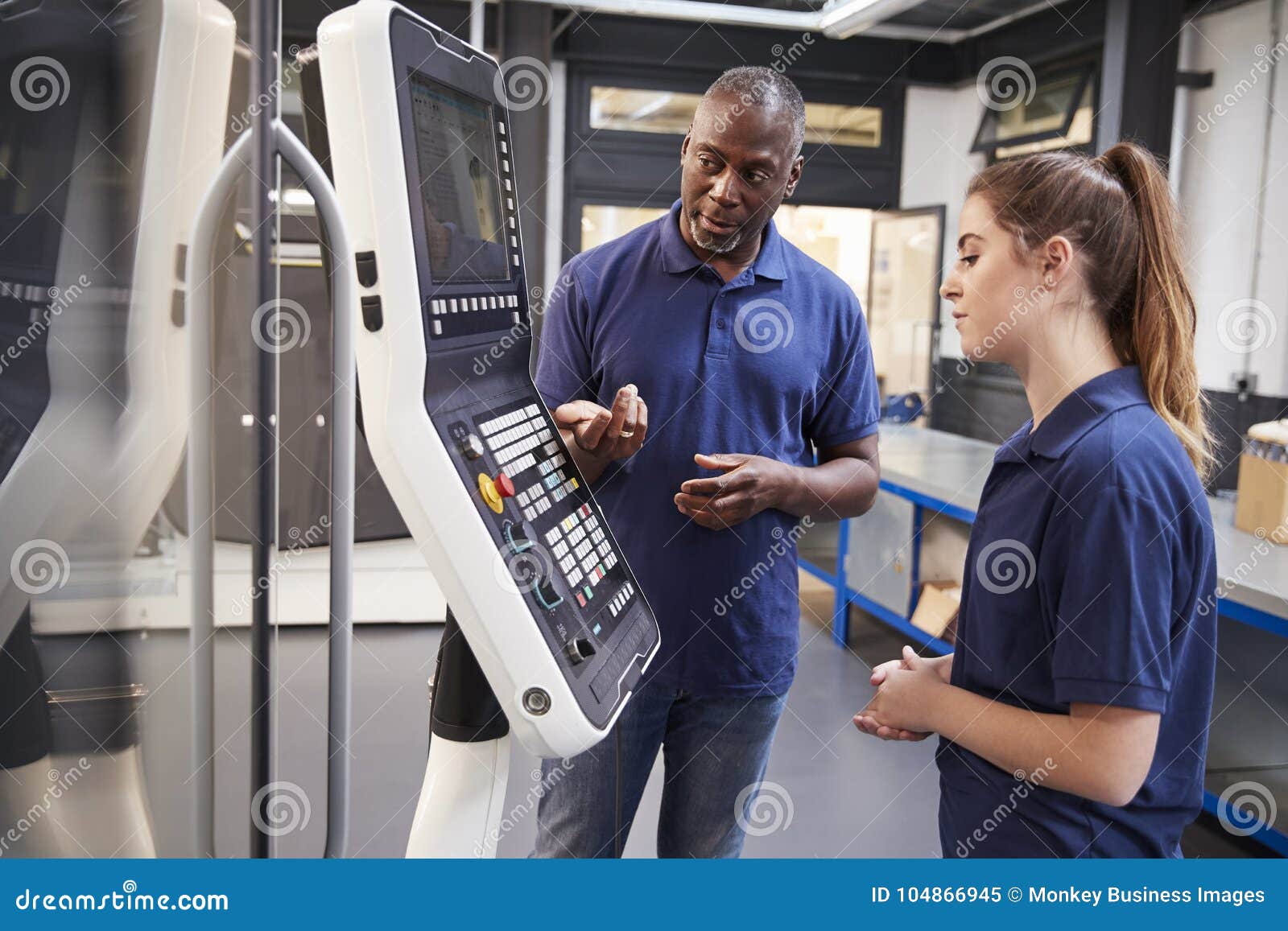 Engineer Showing Apprentice How To Use CNC Tool Making Machine Stock ...