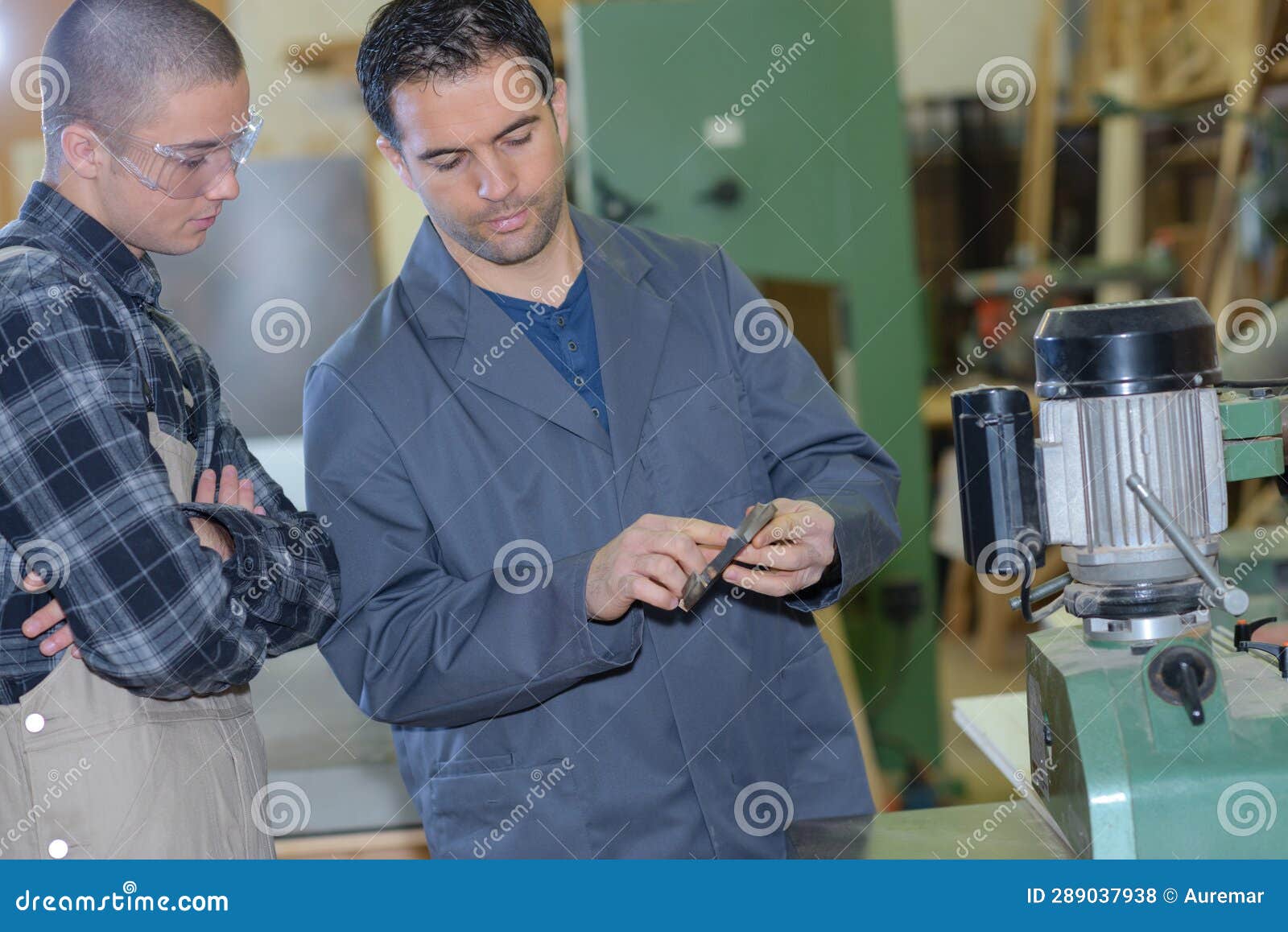 Engineer Showing Apprentice How To Use Drill in Factory Stock Photo ...
