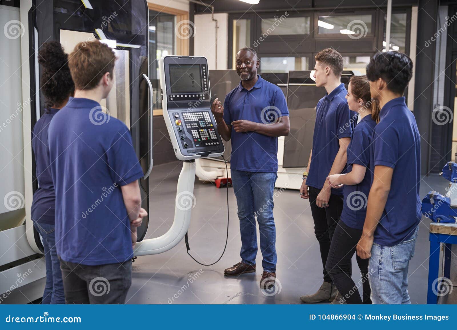 Engineer Showing Apprentices How To Use CNC Tool Making Machine Stock ...