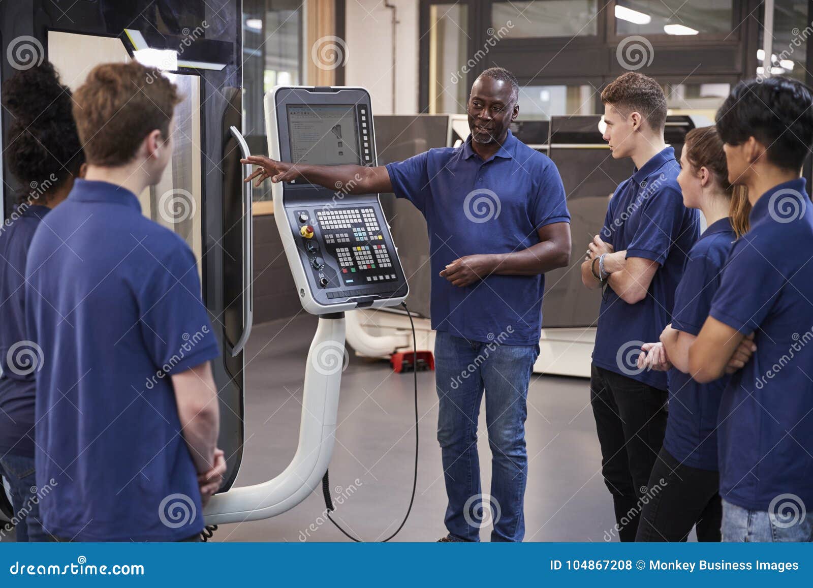Engineer Showing Apprentices How To Use CNC Tool Making Machine Stock ...