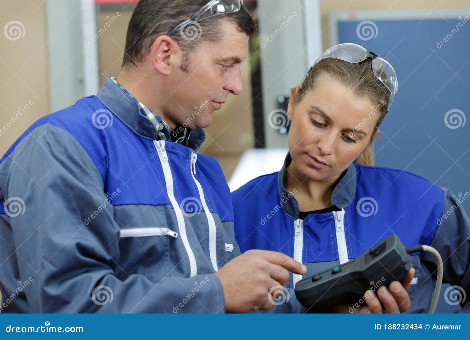 Engineer Showing Female Apprentice Controls To Machine Stock Photo ...