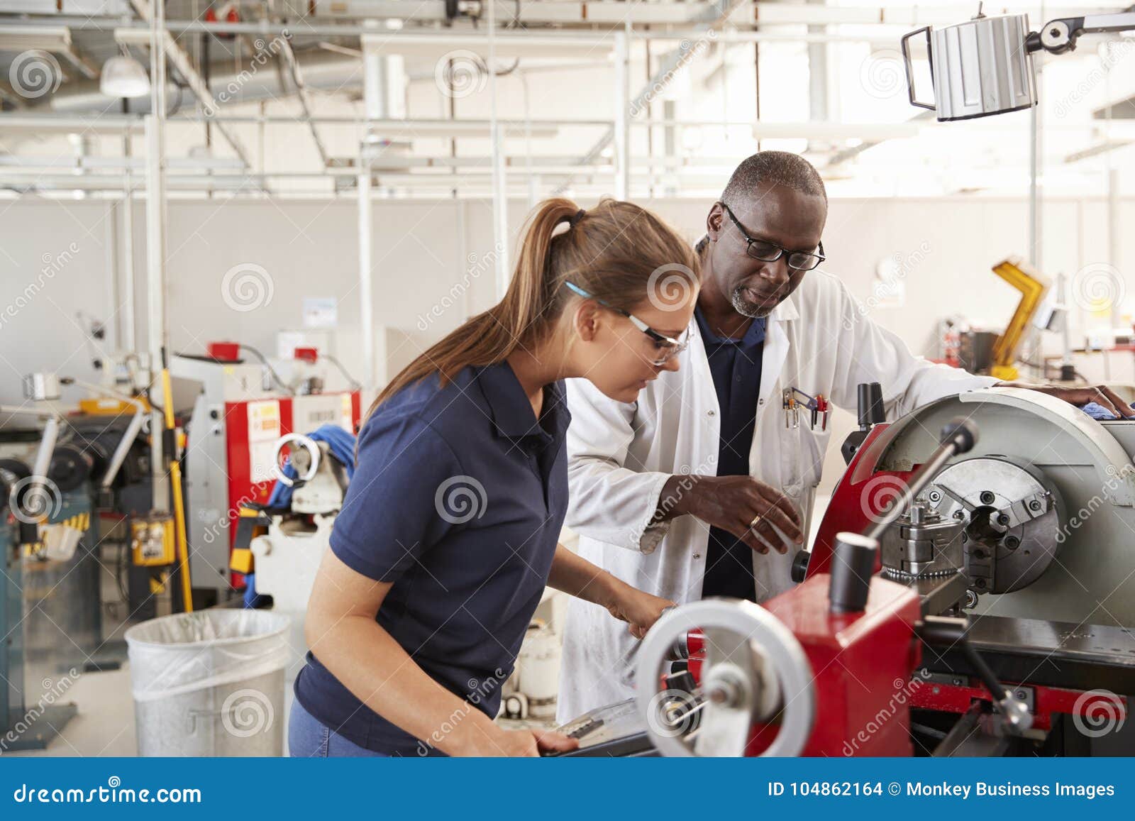 Engineer Showing Female Apprentice How To Operate Machinery Stock Photo ...