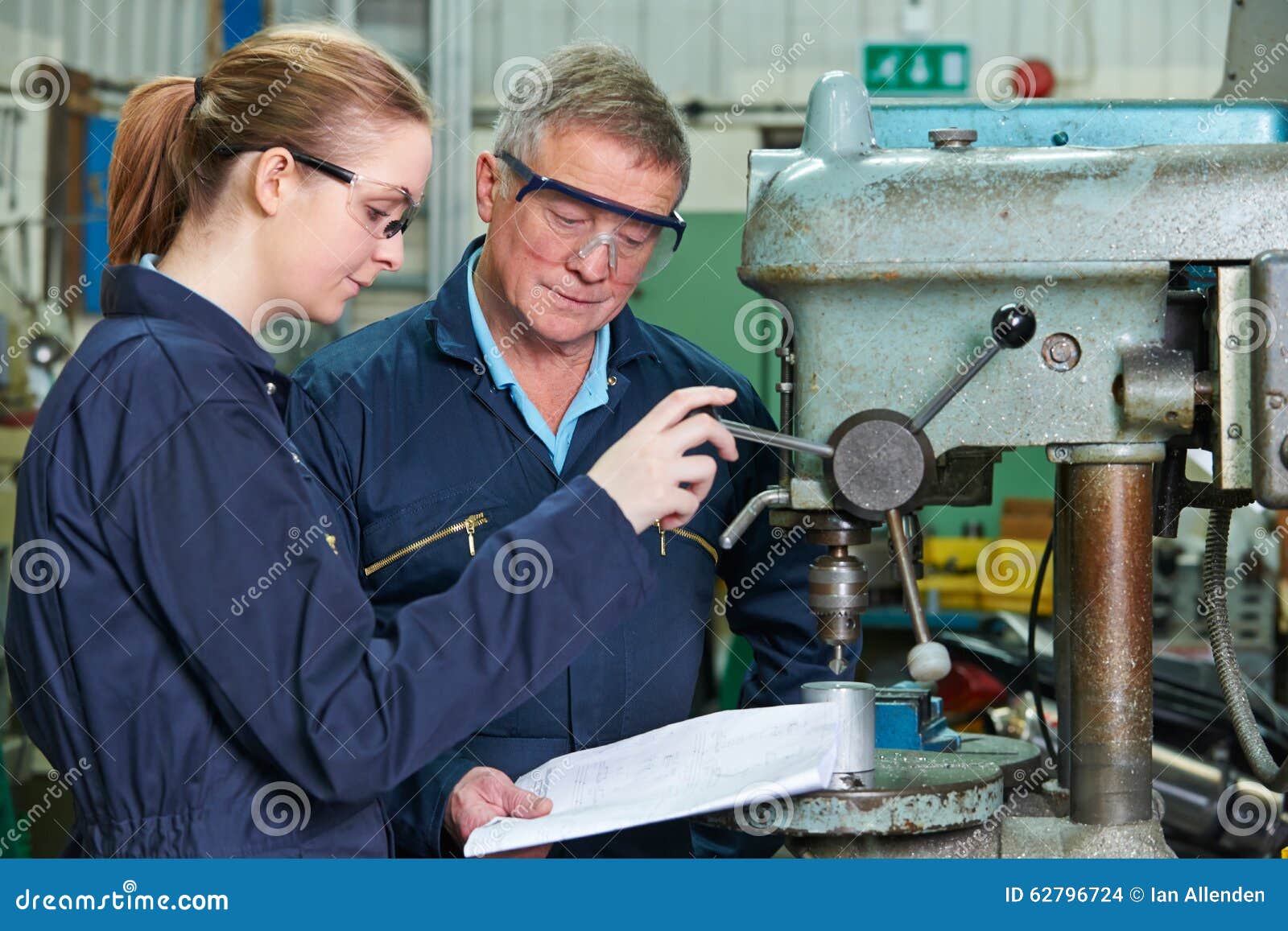 Engineer Showing Female Apprentice How To Use Drill in Factory Stock ...