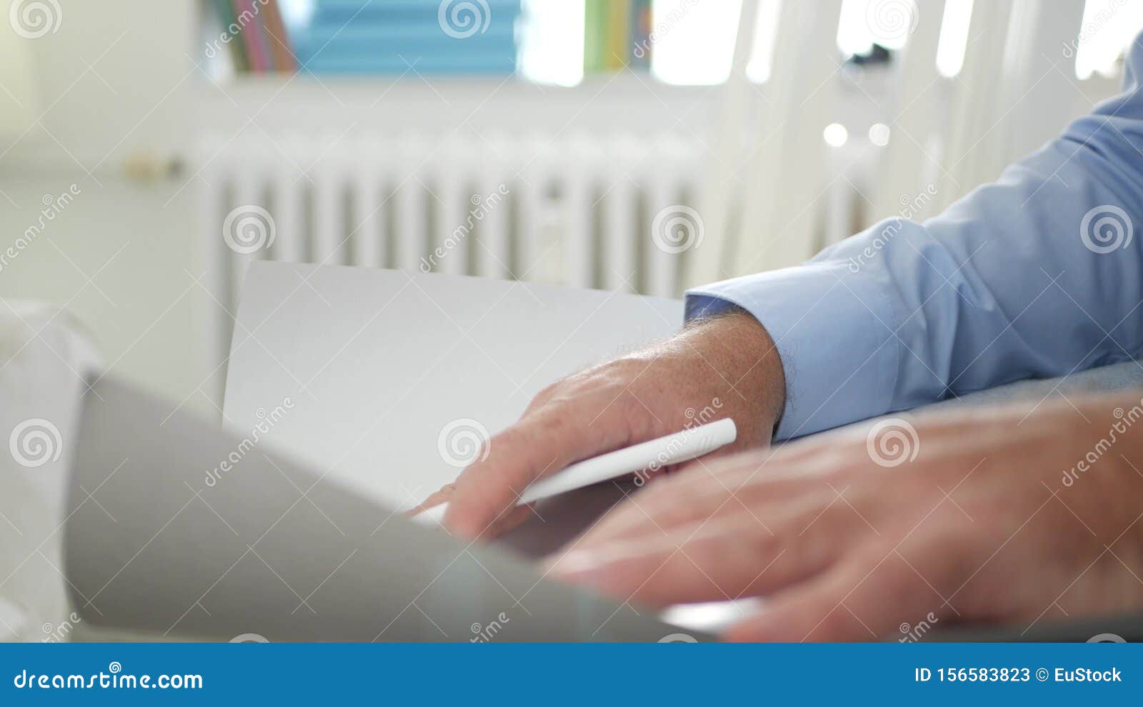 Engineer Sit on a Chair in Office Room Open a Plan and Draw Using a Pen ...