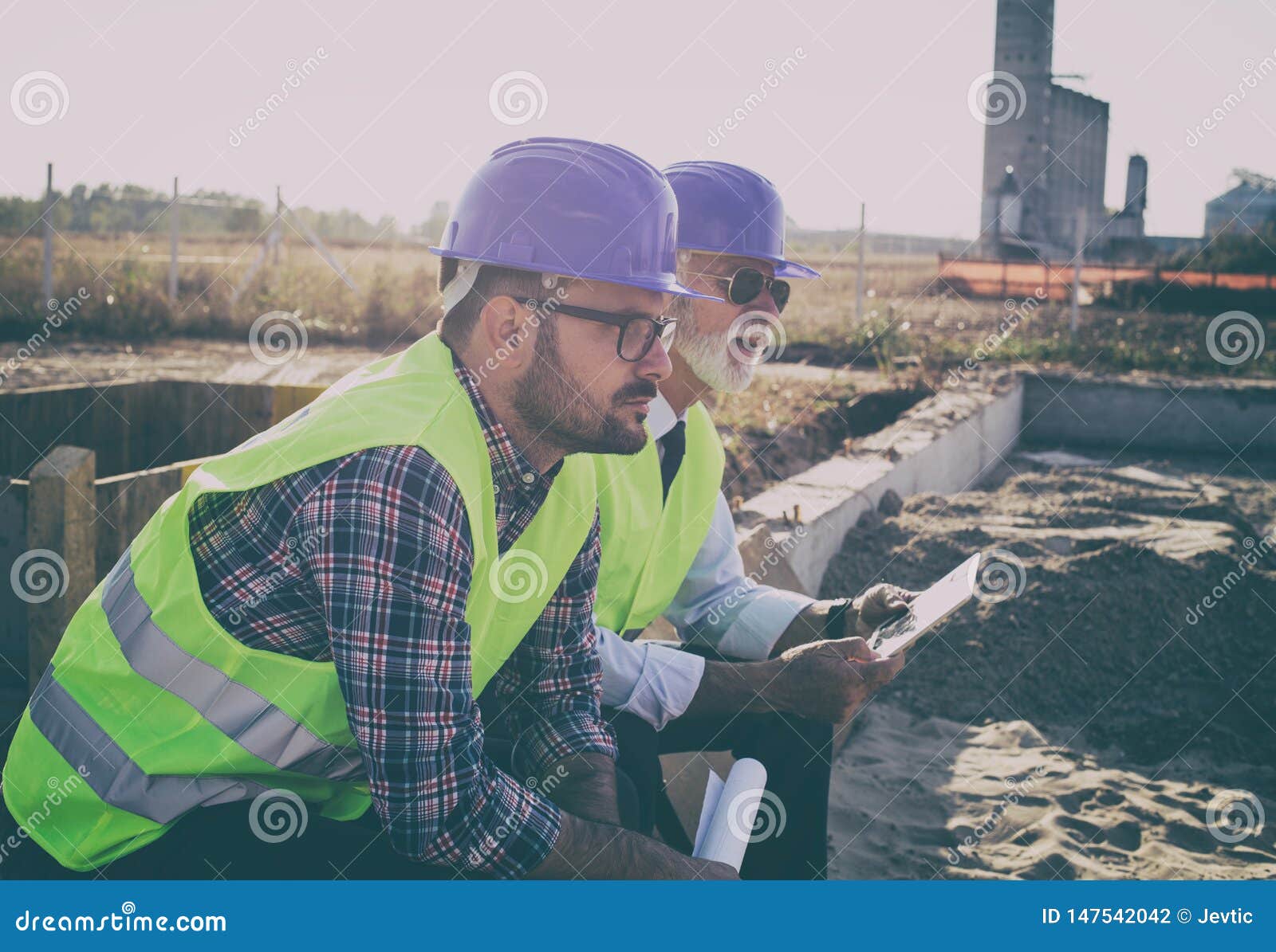 Engineer Sitting Placing Safety Hard Hat On The Table Coffee Cup Pen ...