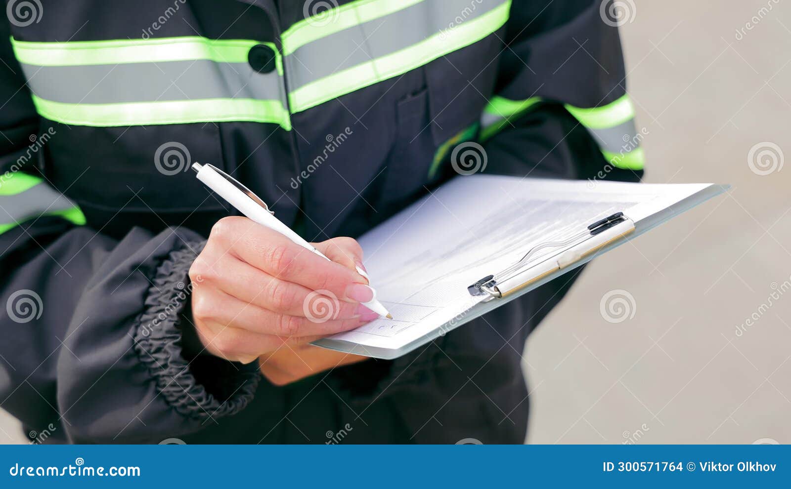 The Engineer in a Special Form Makes a Note in a Notebook. a Woman ...