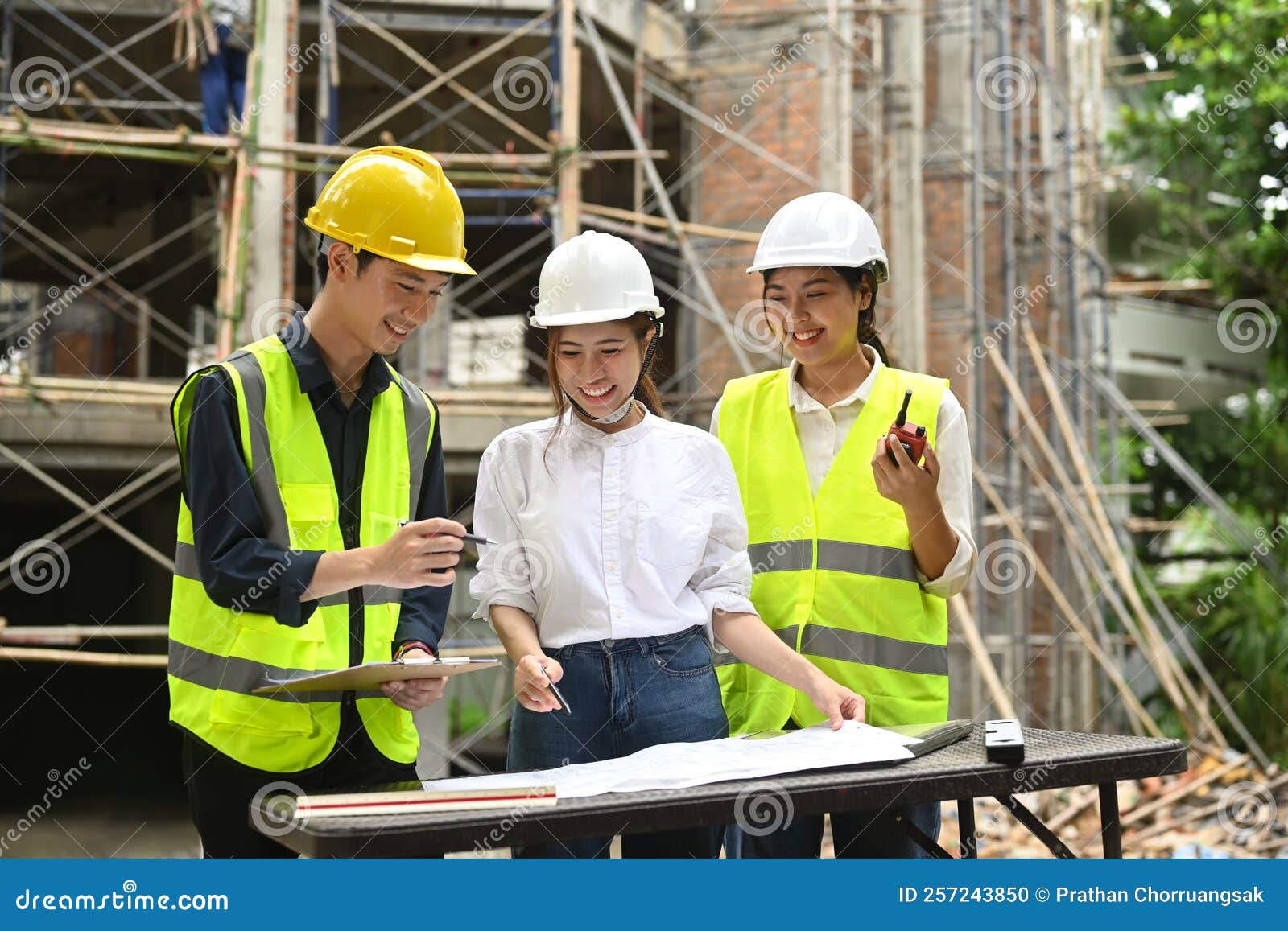 Engineer and Specialists Wearing Safety Helmet are Discussing Work Plan ...