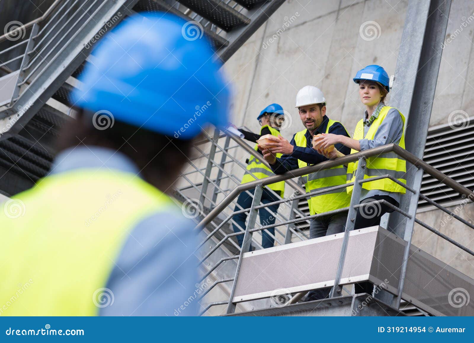 Engineer Standing on Stair Step Talking with Coworkers Stock Photo ...
