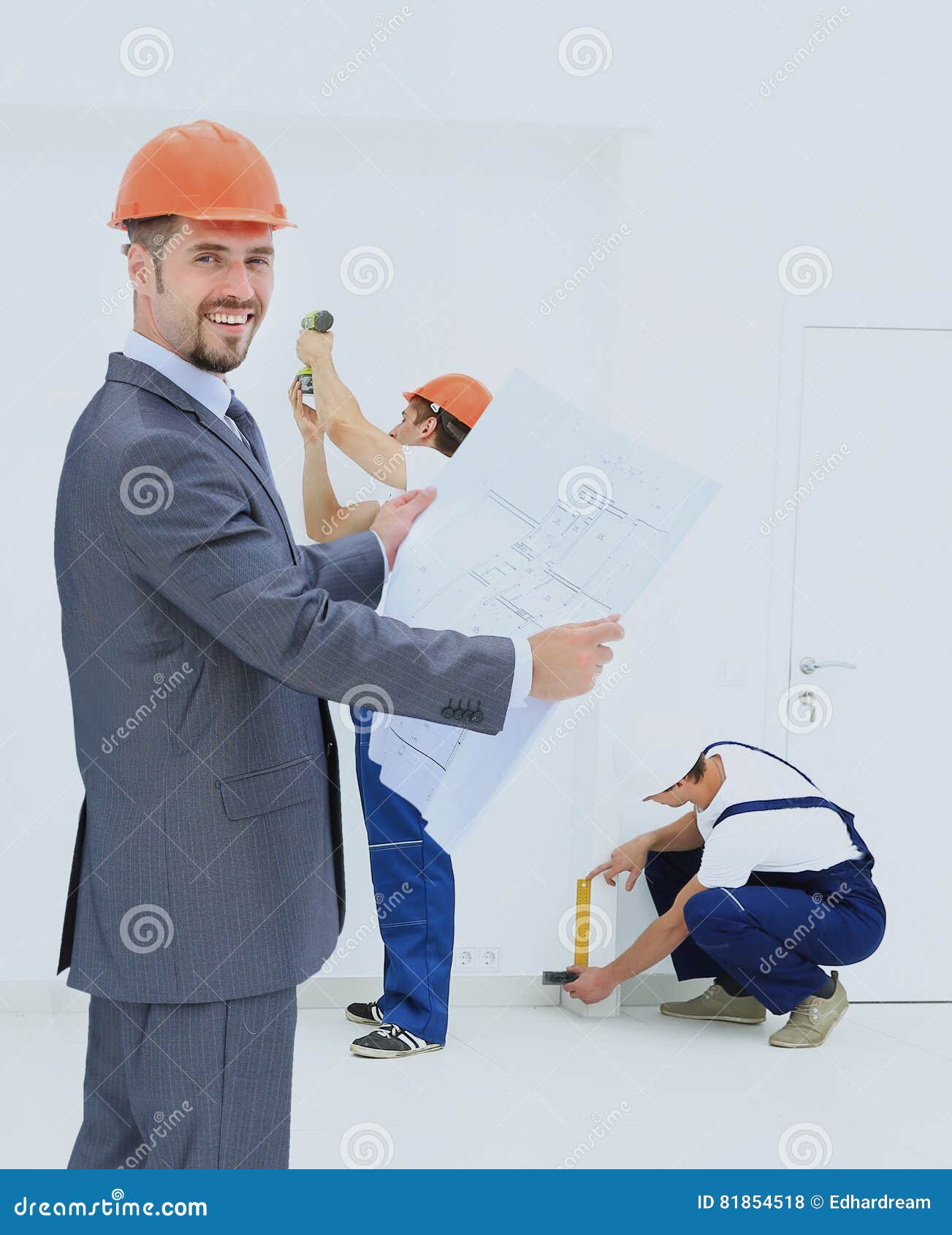 Engineer Studying Blueprints Against the Backdrop of a Team B Stock ...