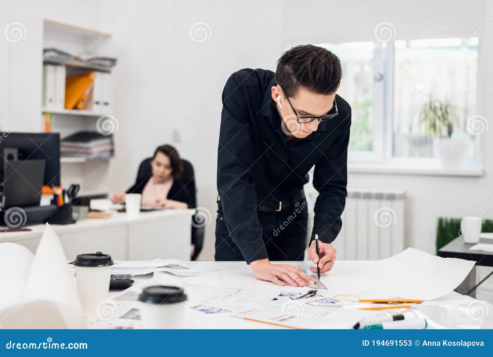 An Engineer Supervisor Working on the Drawings in the Office Stock ...