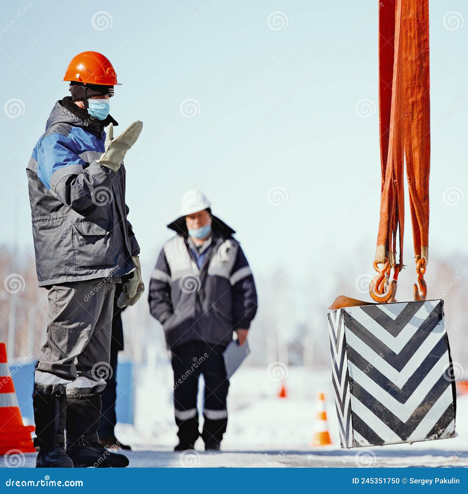 Engineer Takes Exam from Slinger. Worker Gestures To Lift Up Control ...