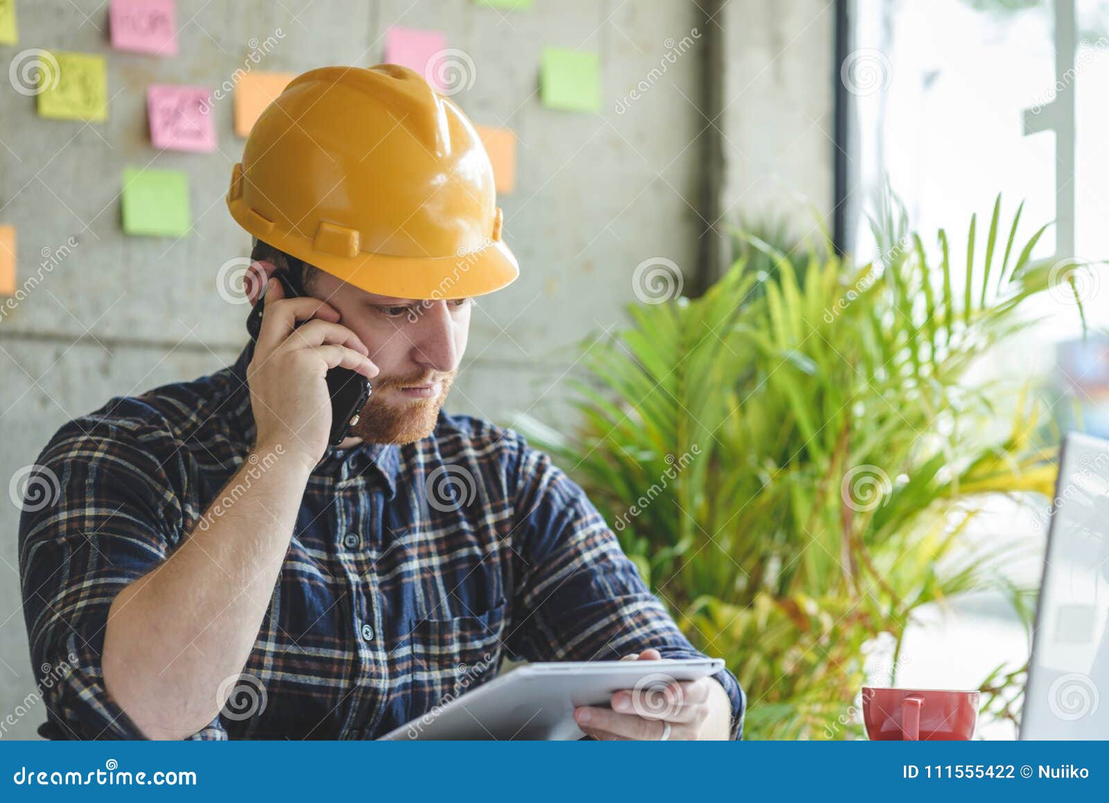Engineer Talking with Phone and Looking at Tablet Stock Photo - Image ...