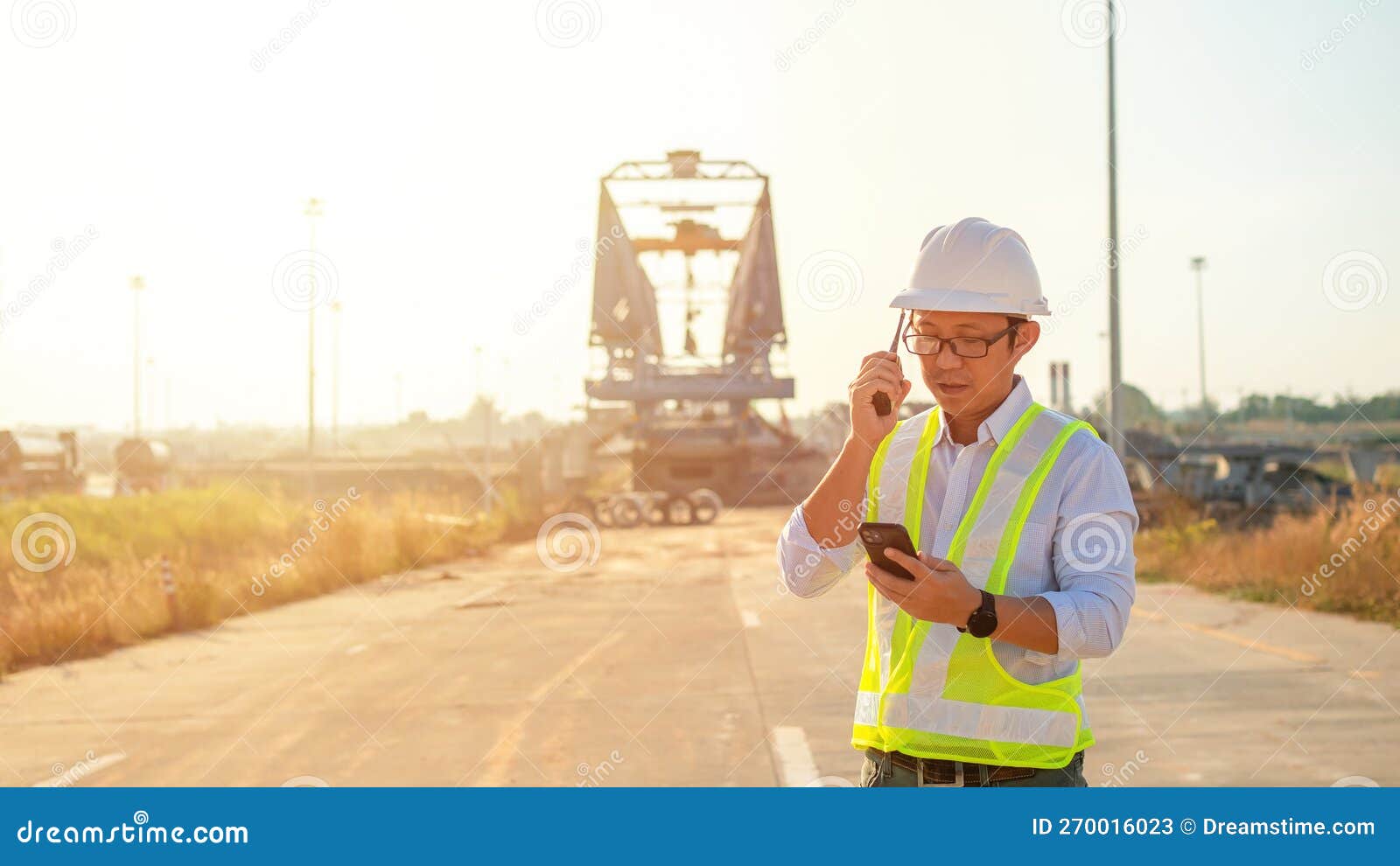 Engineer Talking on Walkie-talkie and Using Smart Phone for Working at ...