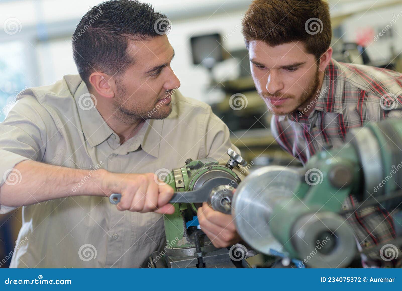 Engineer Teaching Apprentices Using Metal Processing Machines Stock ...