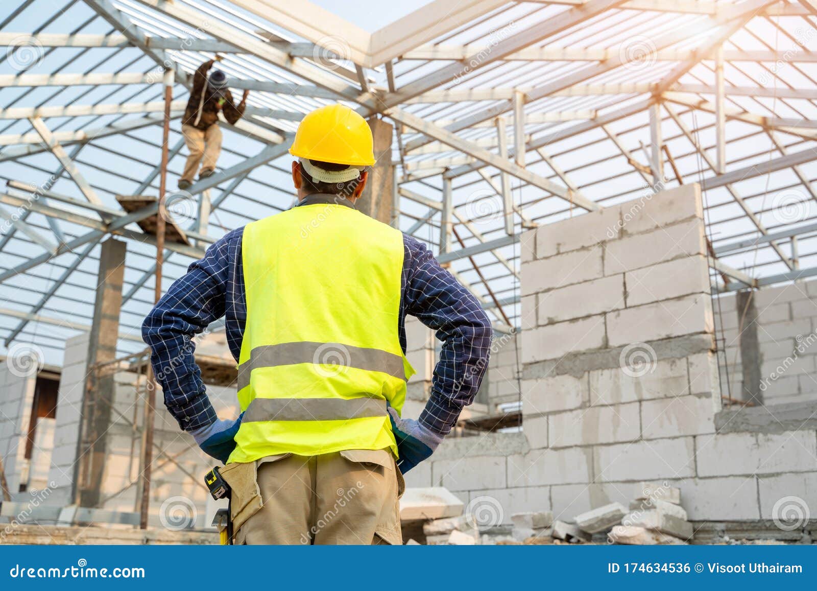 Engineer Looking Up and Analyzing an Unfinished Construction Project ...