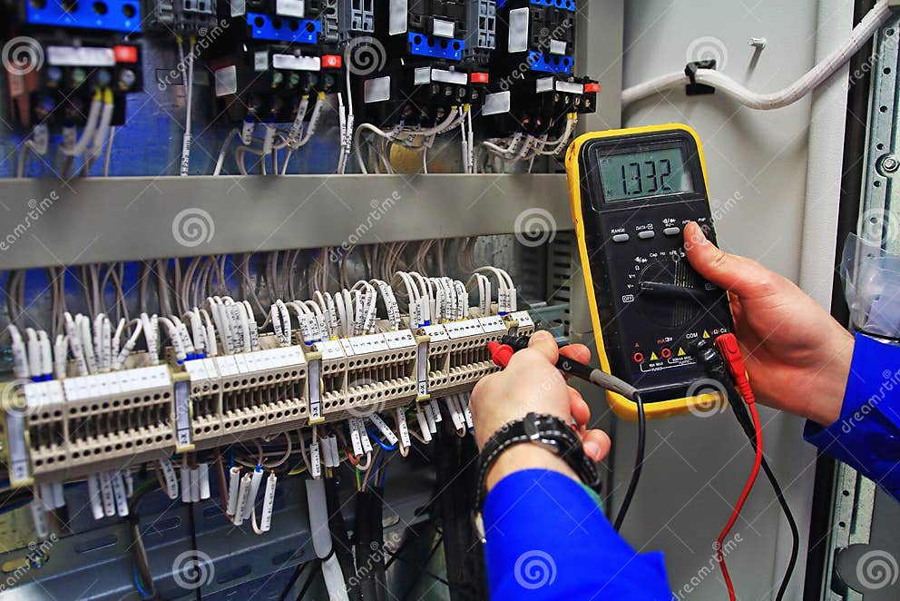 Engineer Tests Industrial Electrical Circuits with a Multimeter in the ...