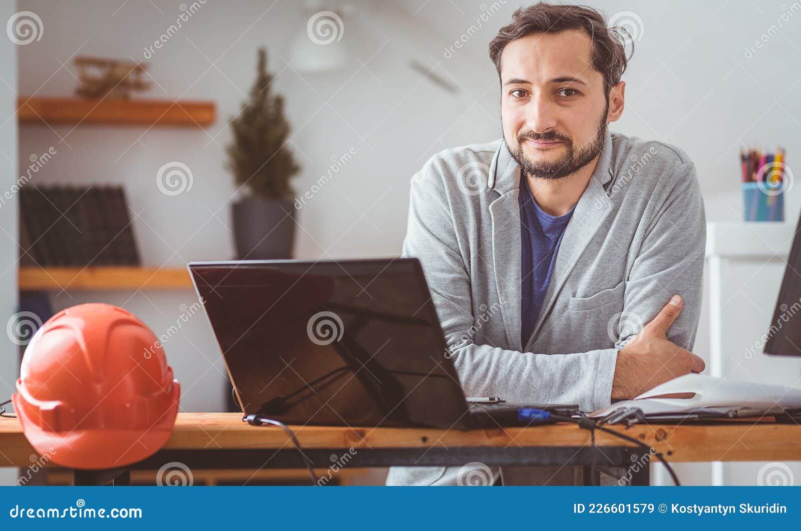 The Engineer is Thinking and Smiling while Working with Drawings and ...