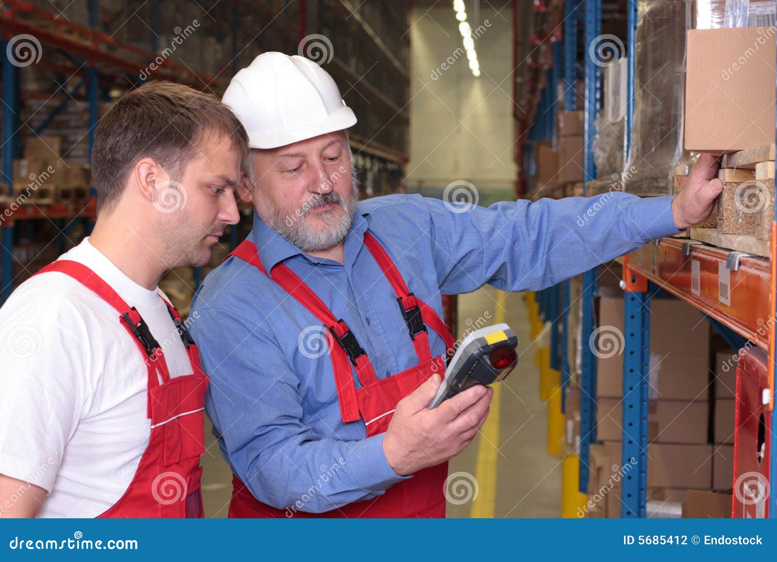 An Employee Of The Warehouse Of An Online Store Scans The Barcodes On ... An Employee Of The Warehouse Of An Online Store Scans The Barcodes On ...