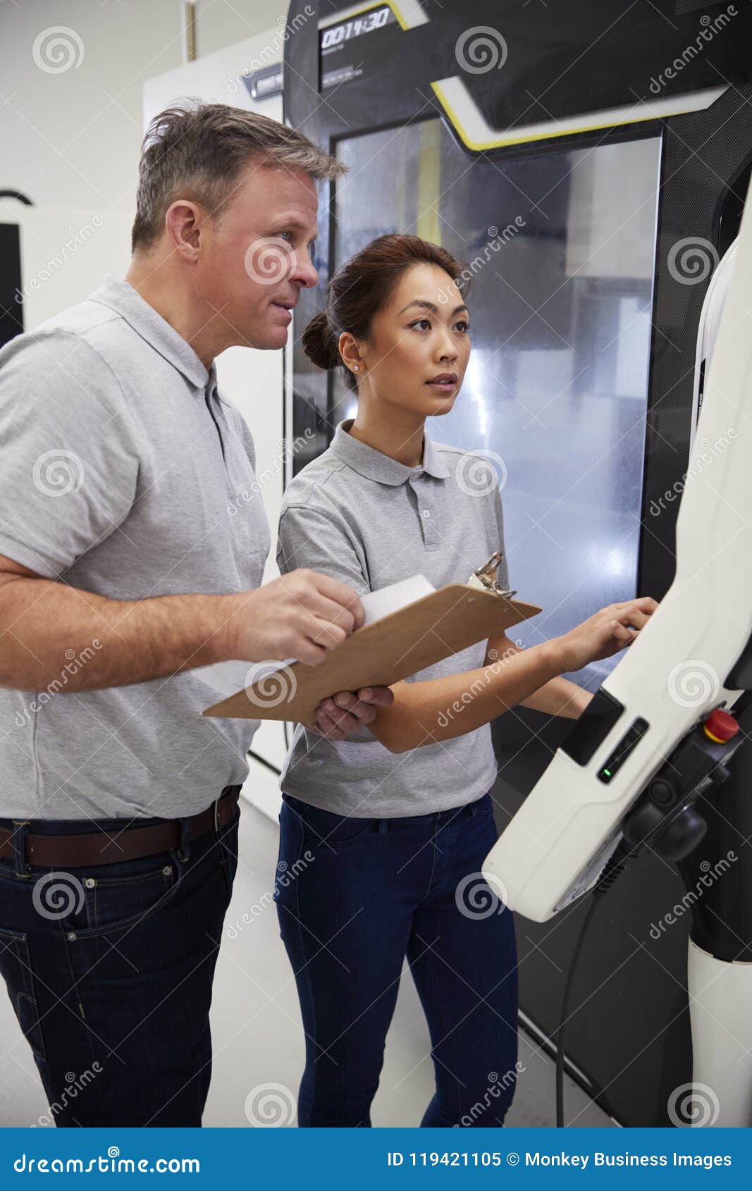 Engineer Training Female Apprentice To Use CNC Machine in Factor Stock ...