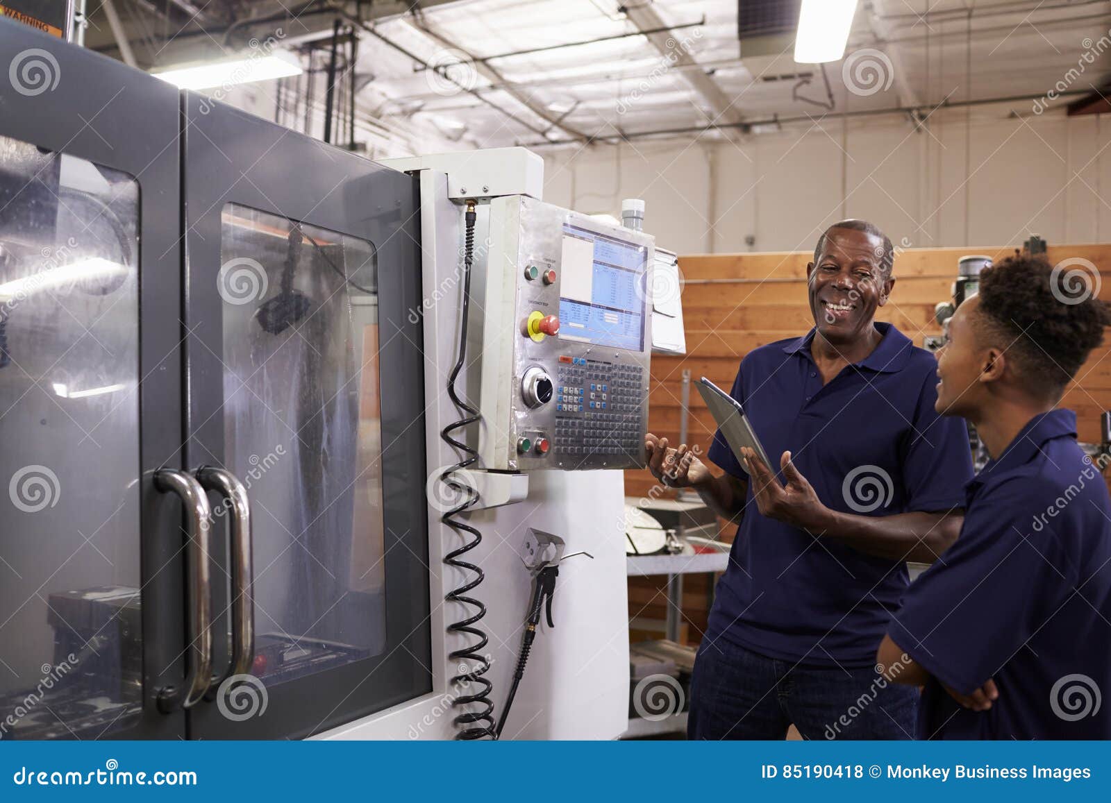 Engineer Training Young Male Apprentice on CNC Machine Stock Photo ...