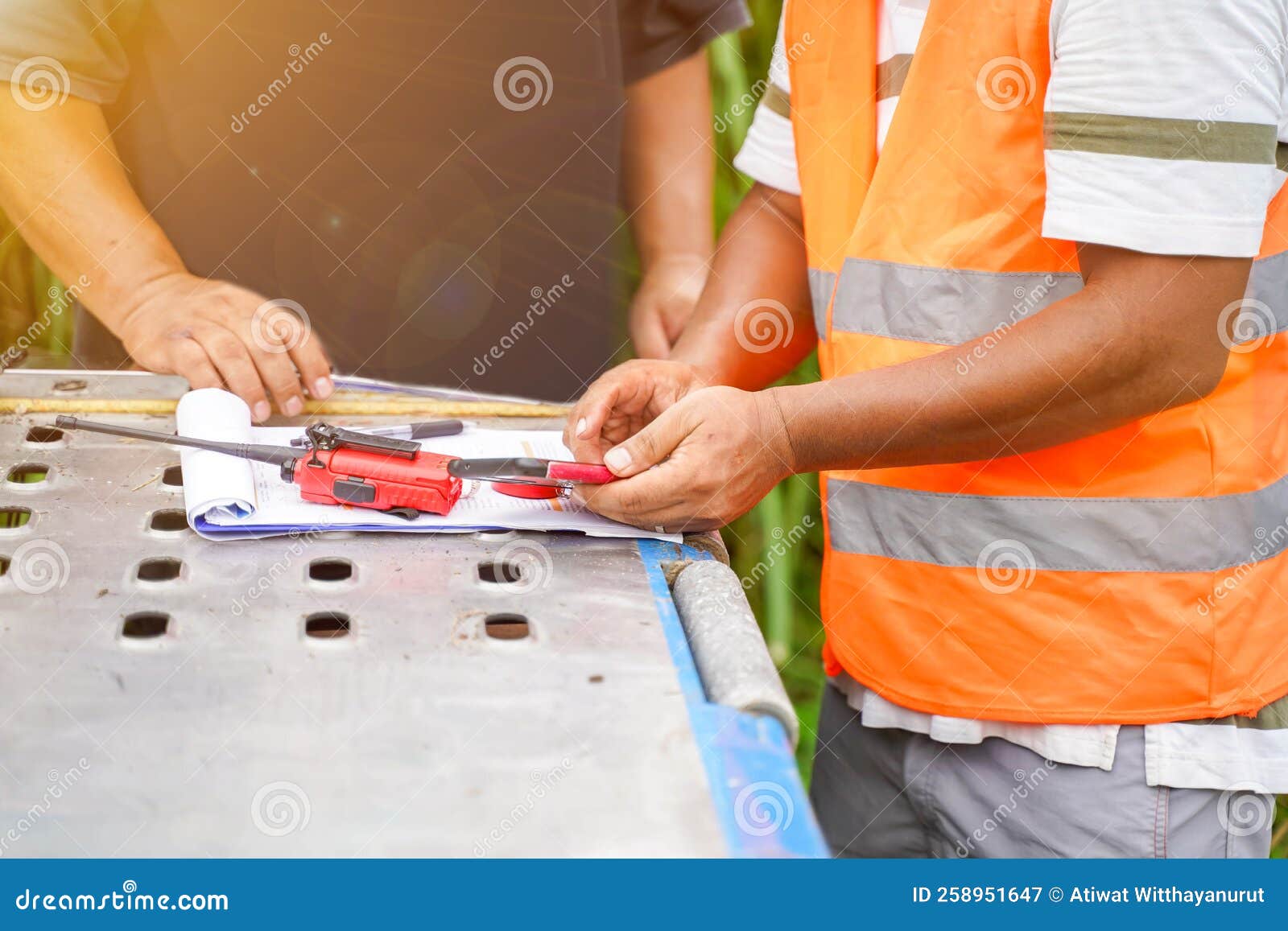 An Engineer is Using a Cell Phone To Check Prices and Work Meetings ...