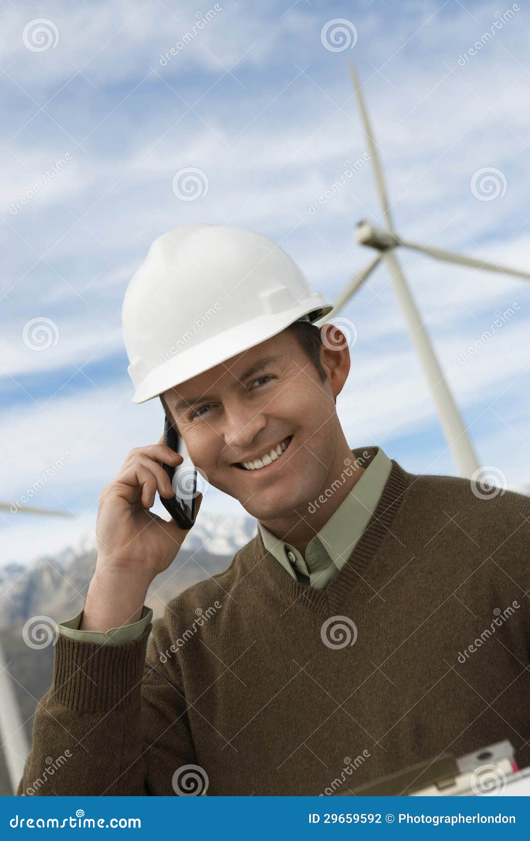 Engineer Using Mobile Phone at Wind Farm Stock Photo - Image of ...
