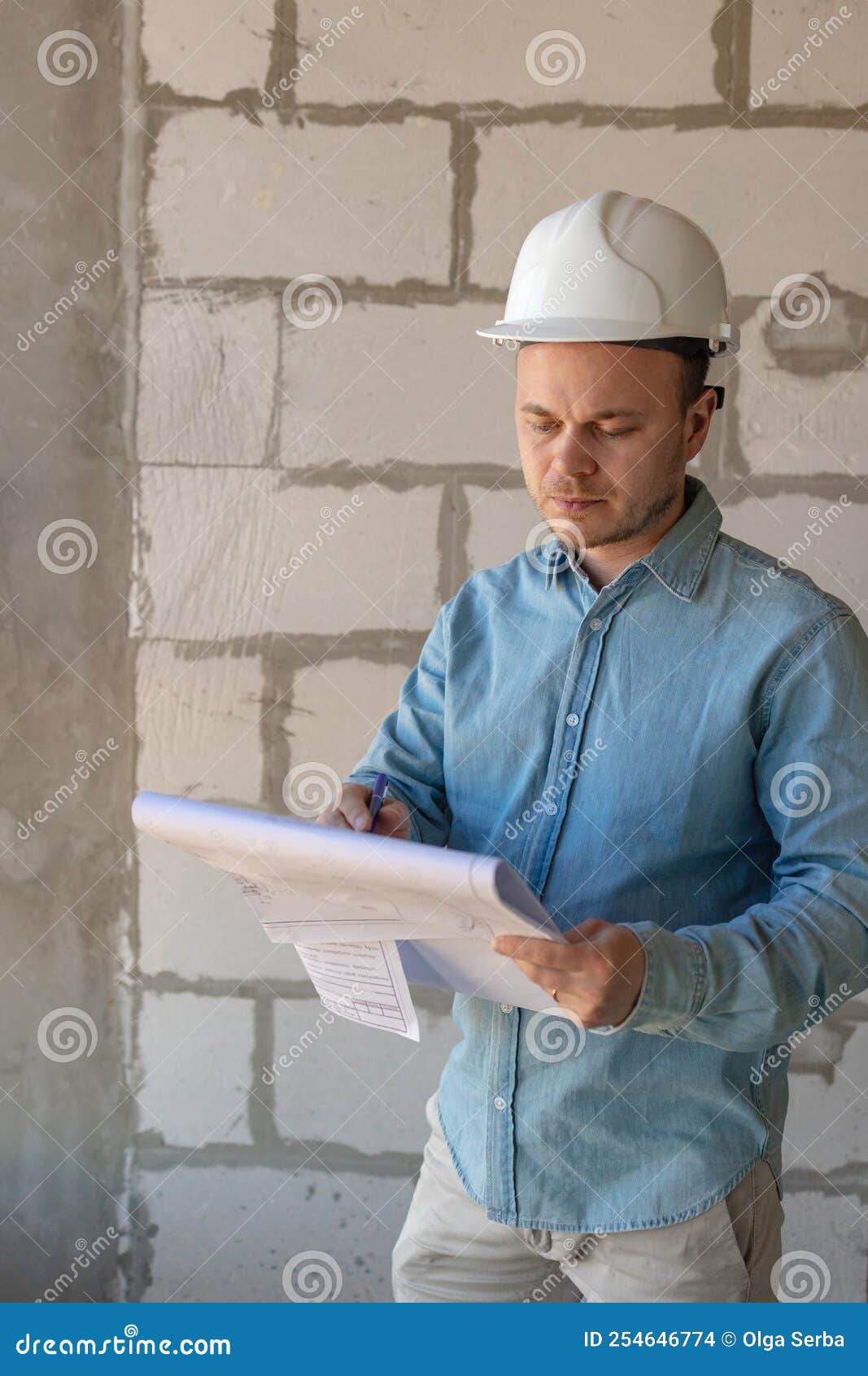 Engineer in a White Helmet with a Project in His Hands is Thoughtful and Professional. Stock ...