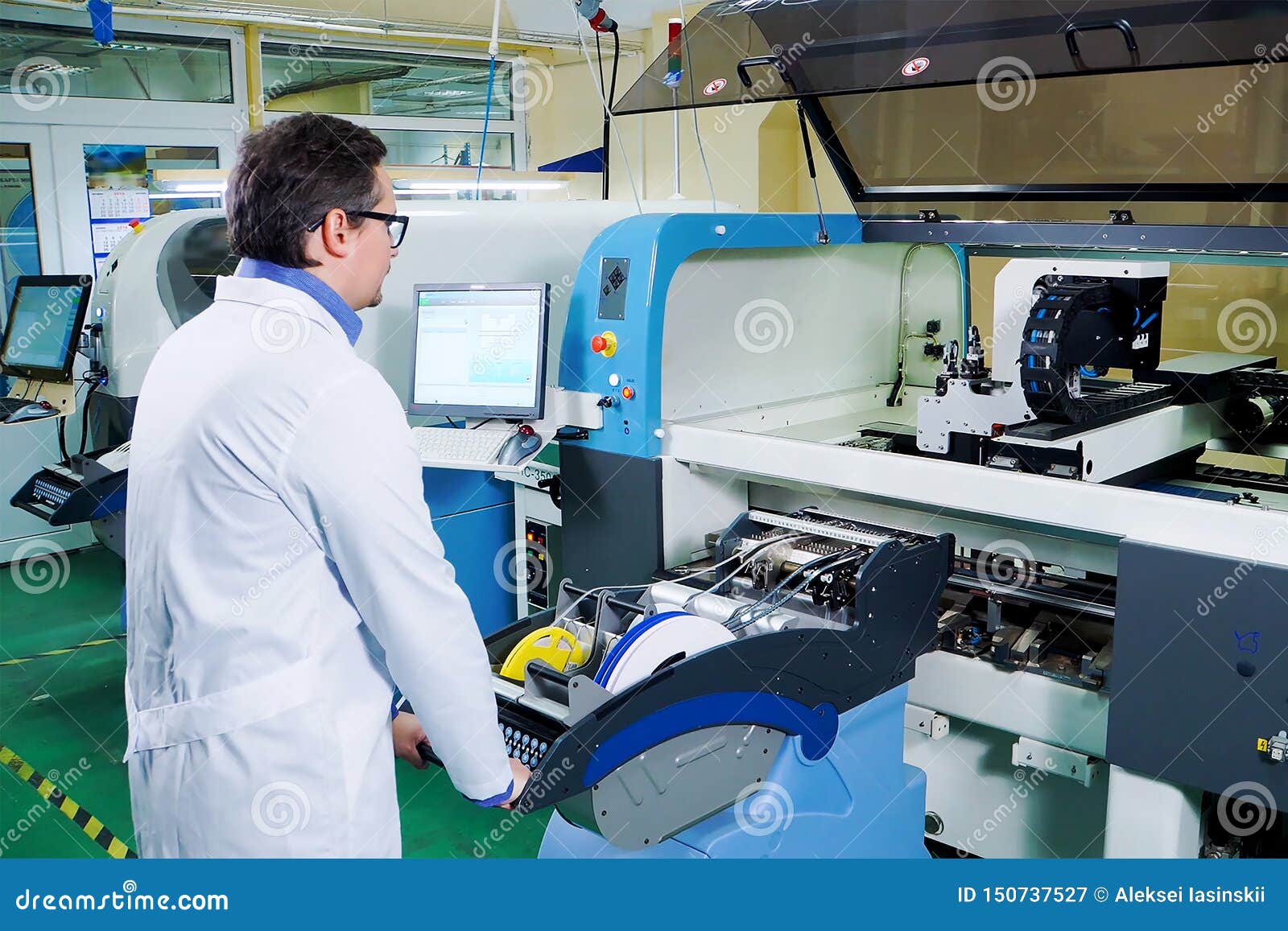The Engineer In A White Robe And Glasses Works For The Surface Mount ...