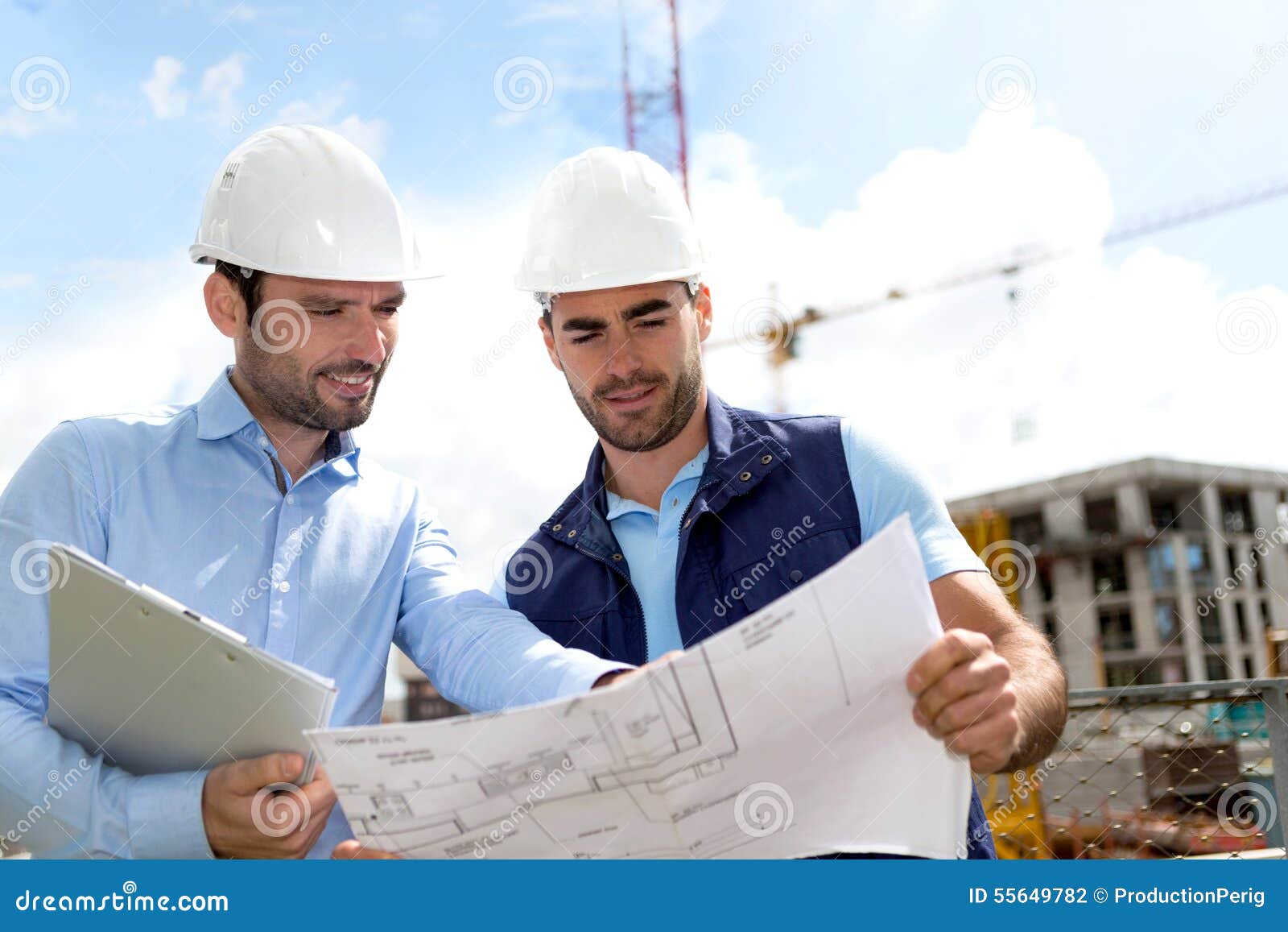Engineer and Worker Checking Plan on Construction Site Stock Photo ...