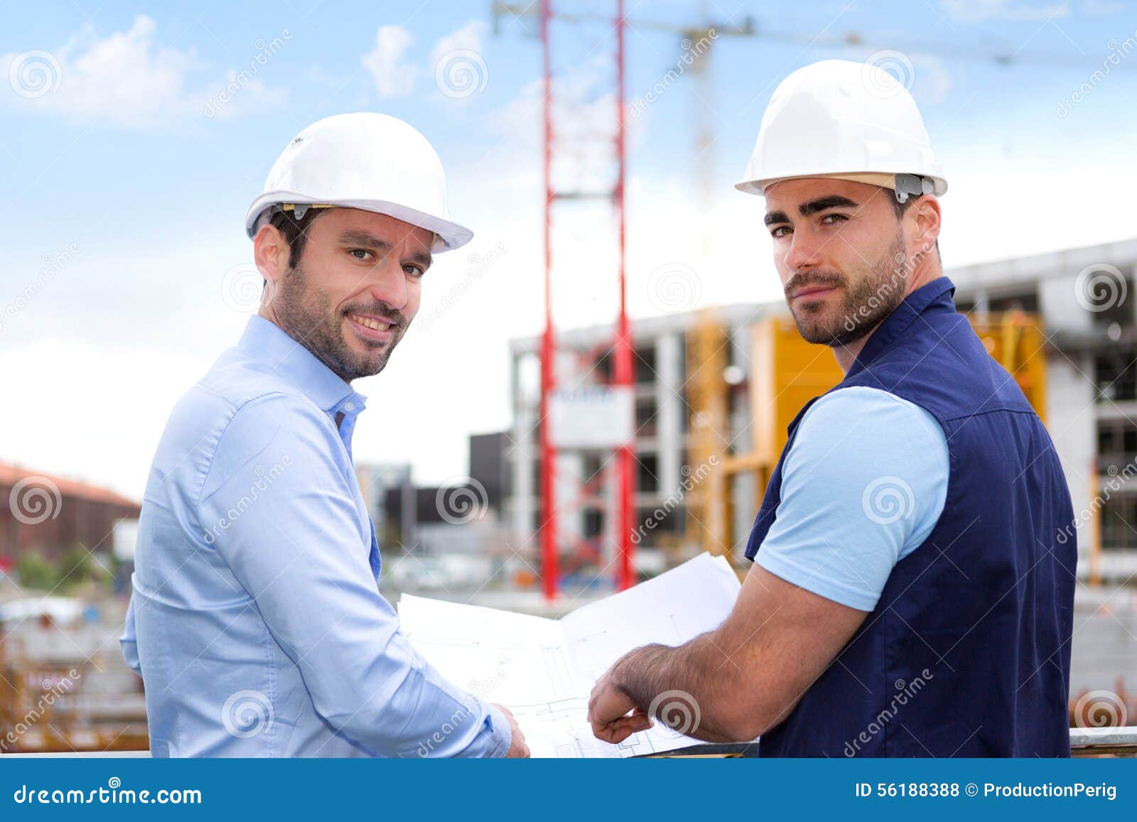 Engineer and Worker Checking Plan on Construction Site Stock Photo ...