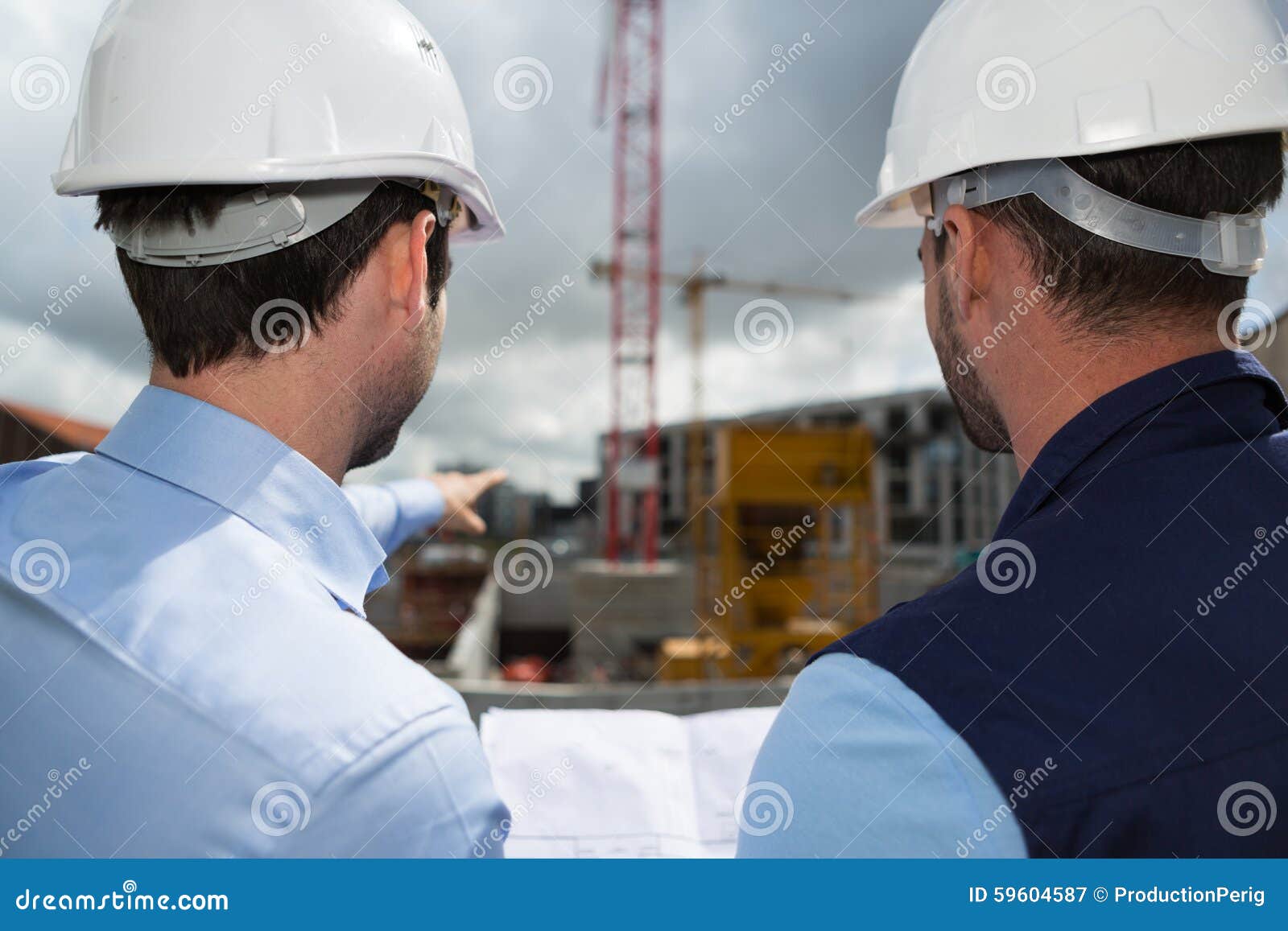 Engineer and Worker Checking Plan on Construction Site Stock Image ...