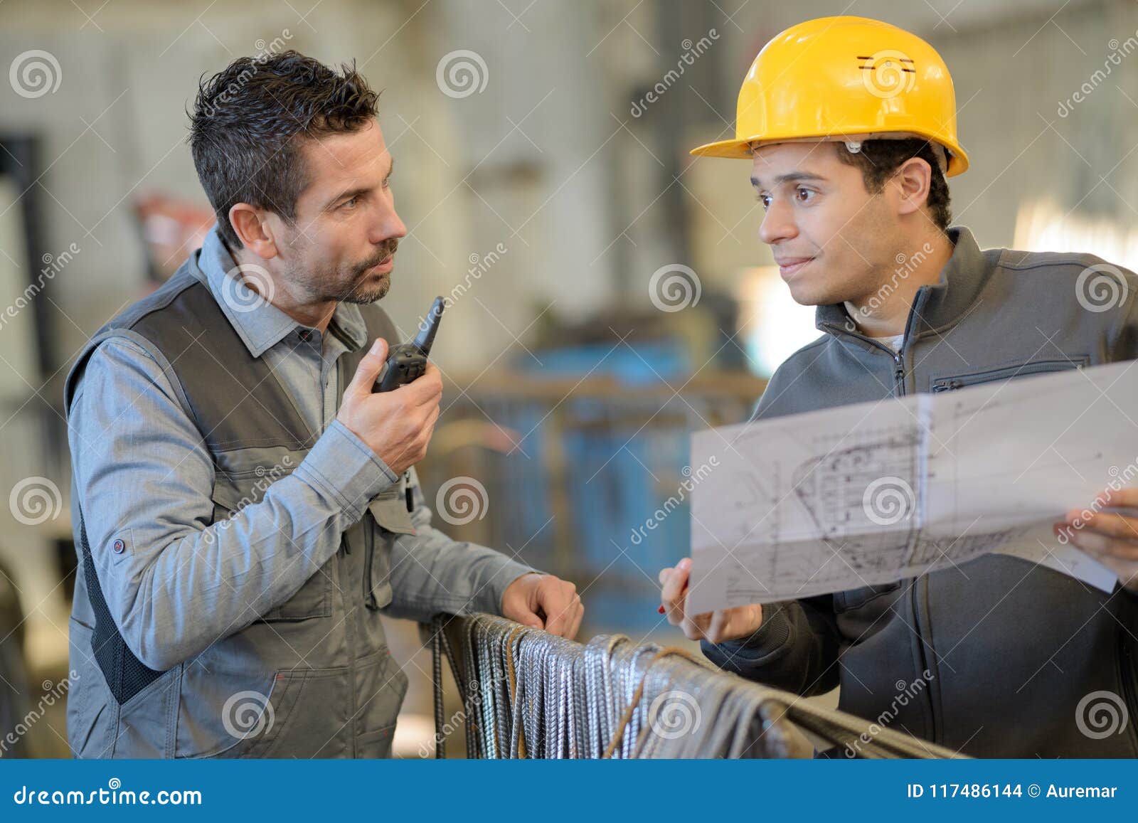 Engineer and Worker Checking Plan on Construction Site Stock Photo ...
