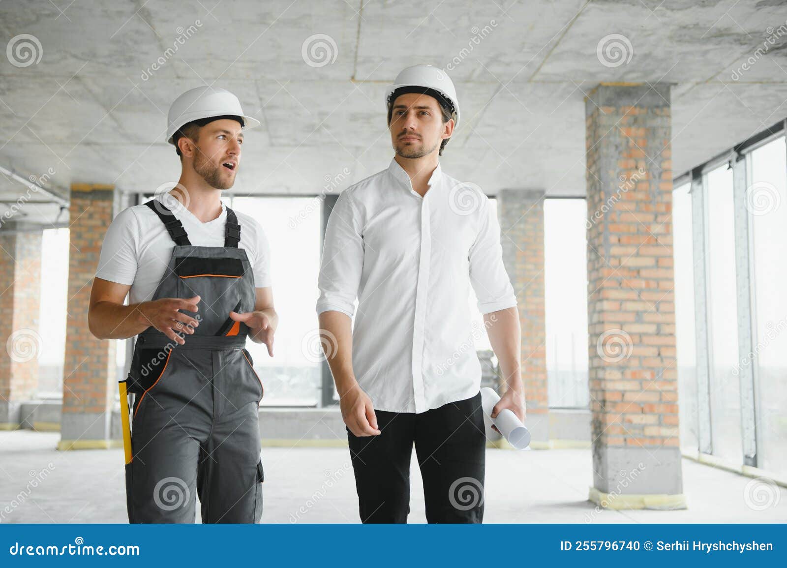 Engineer and Worker Checking Project at Building Site Background ...