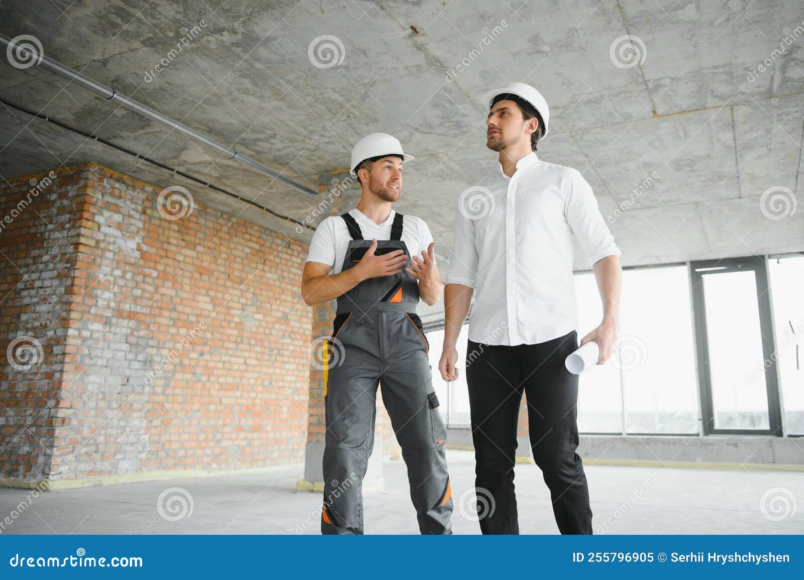 Engineer and Worker Checking Project at Building Site Background ...