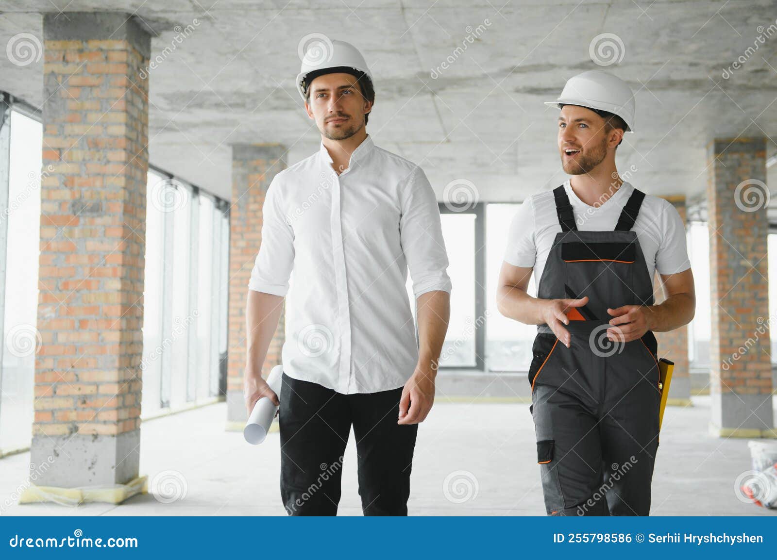 Engineer and Worker Checking Project at Building Site Background ...