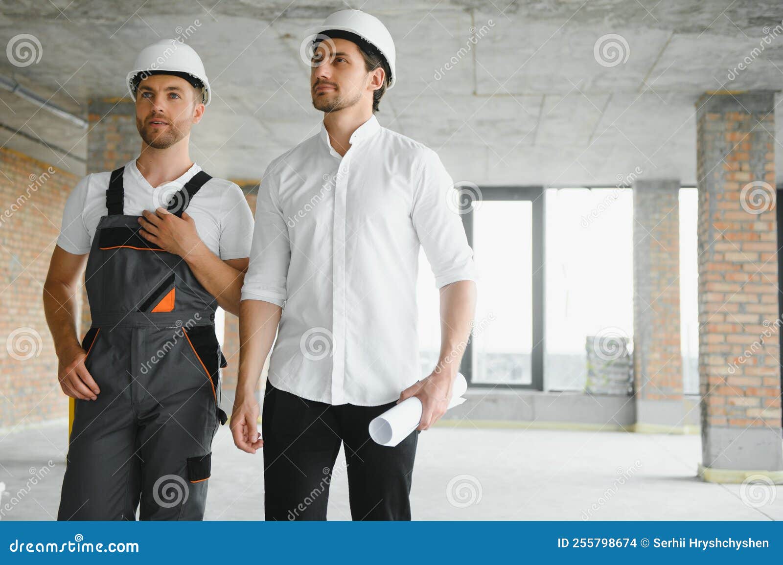 Engineer and Worker Checking Project at Building Site Background ...