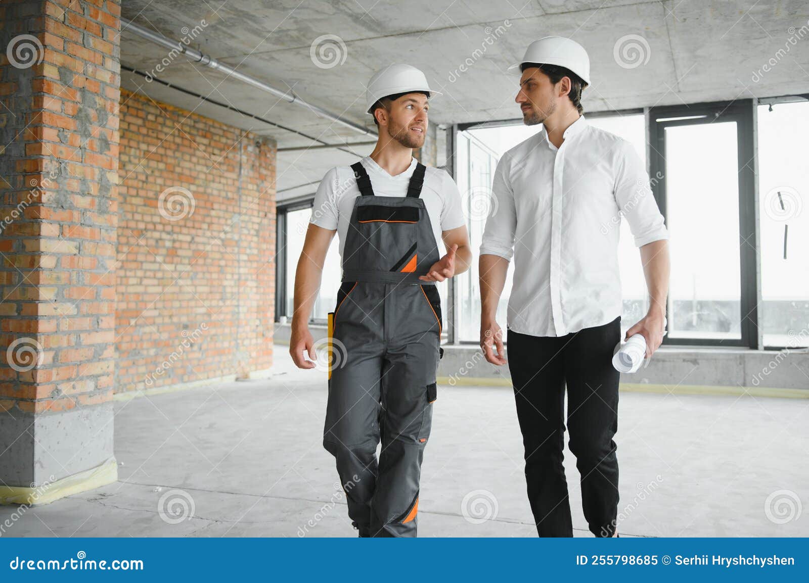 Engineer and Worker Checking Project at Building Site Background ...