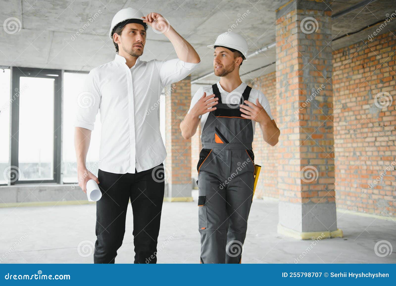 Engineer and Worker Checking Project at Building Site Background ...