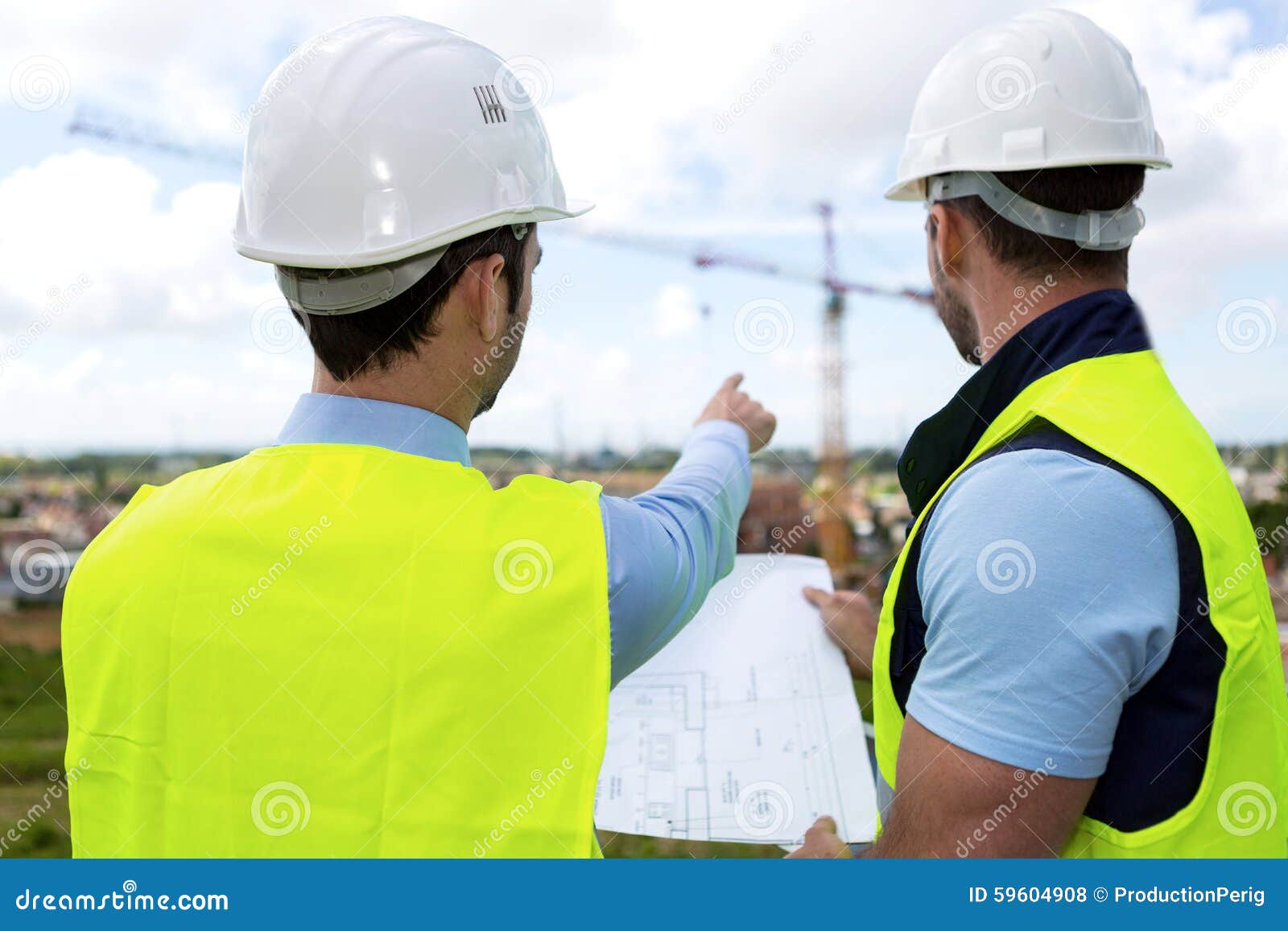 Engineer and Worker Watching Blueprint on Construction Site Stock Photo ...