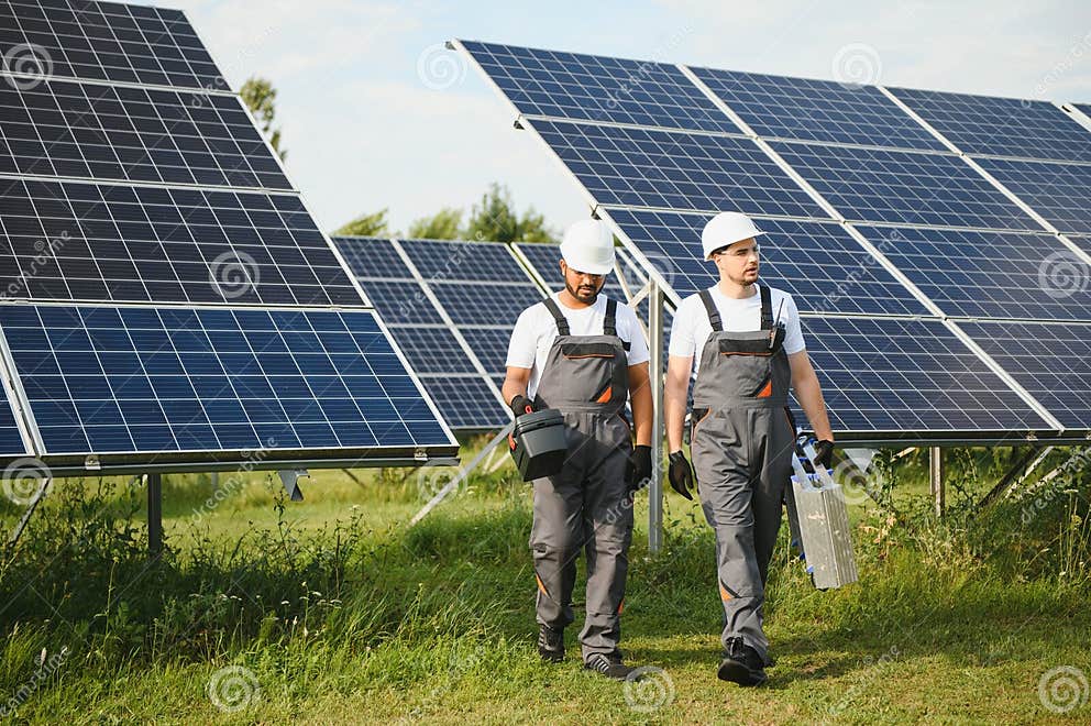 Engineer Worker Working in Solar Panels Power Farm. Two Technician ...