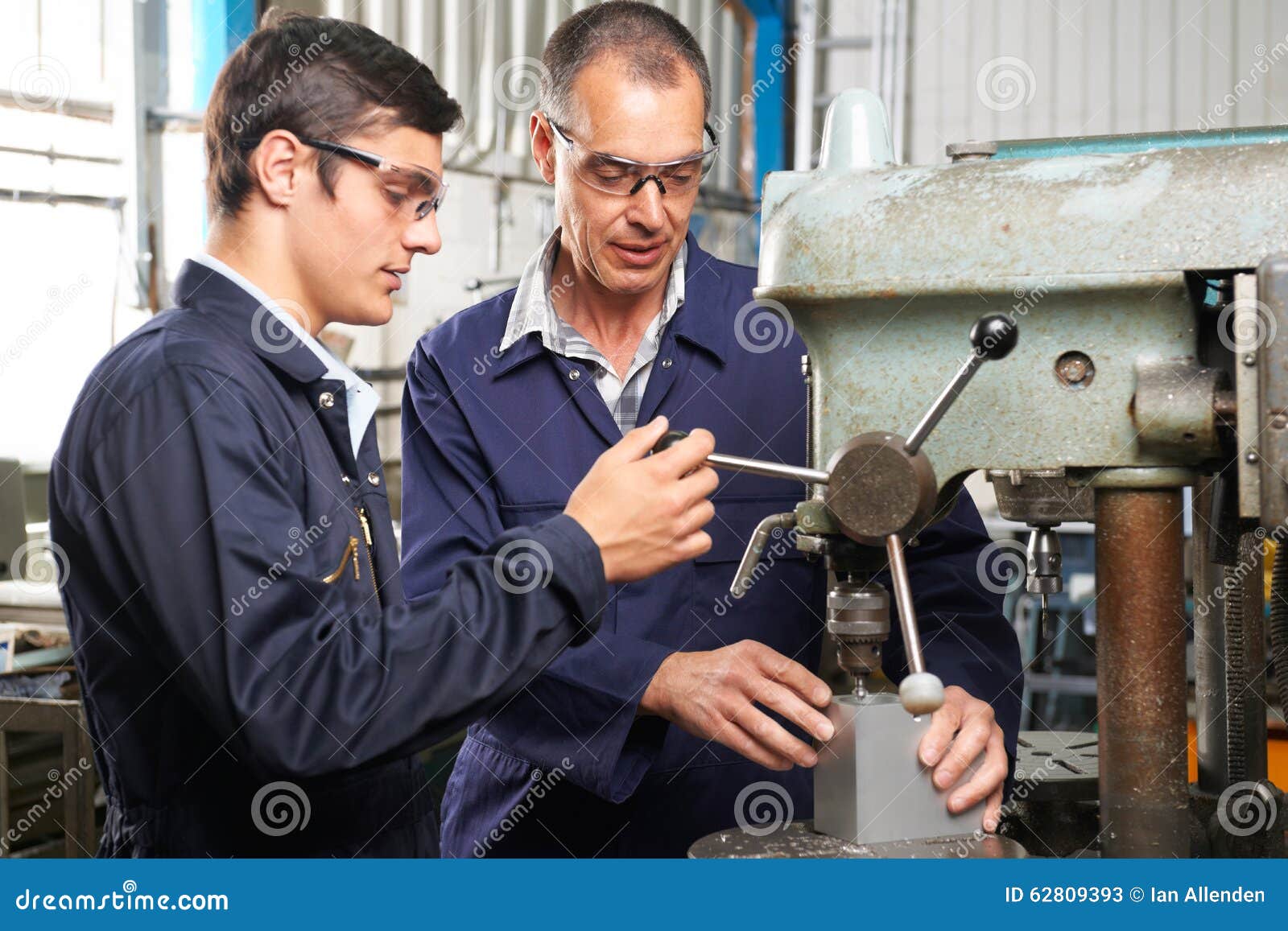 Engineer Working with Apprentice Using Drill Stock Image - Image of ...
